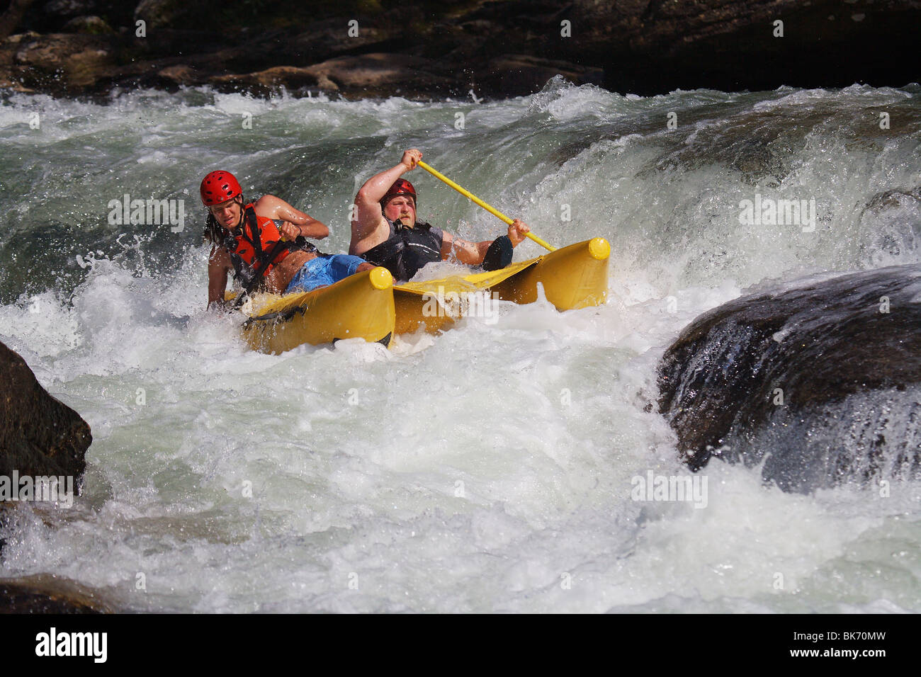 TWO MEN IN PONTOON RAFT BOAT SPLASHING THROUGH RAPIDS BULL SLUICE ...