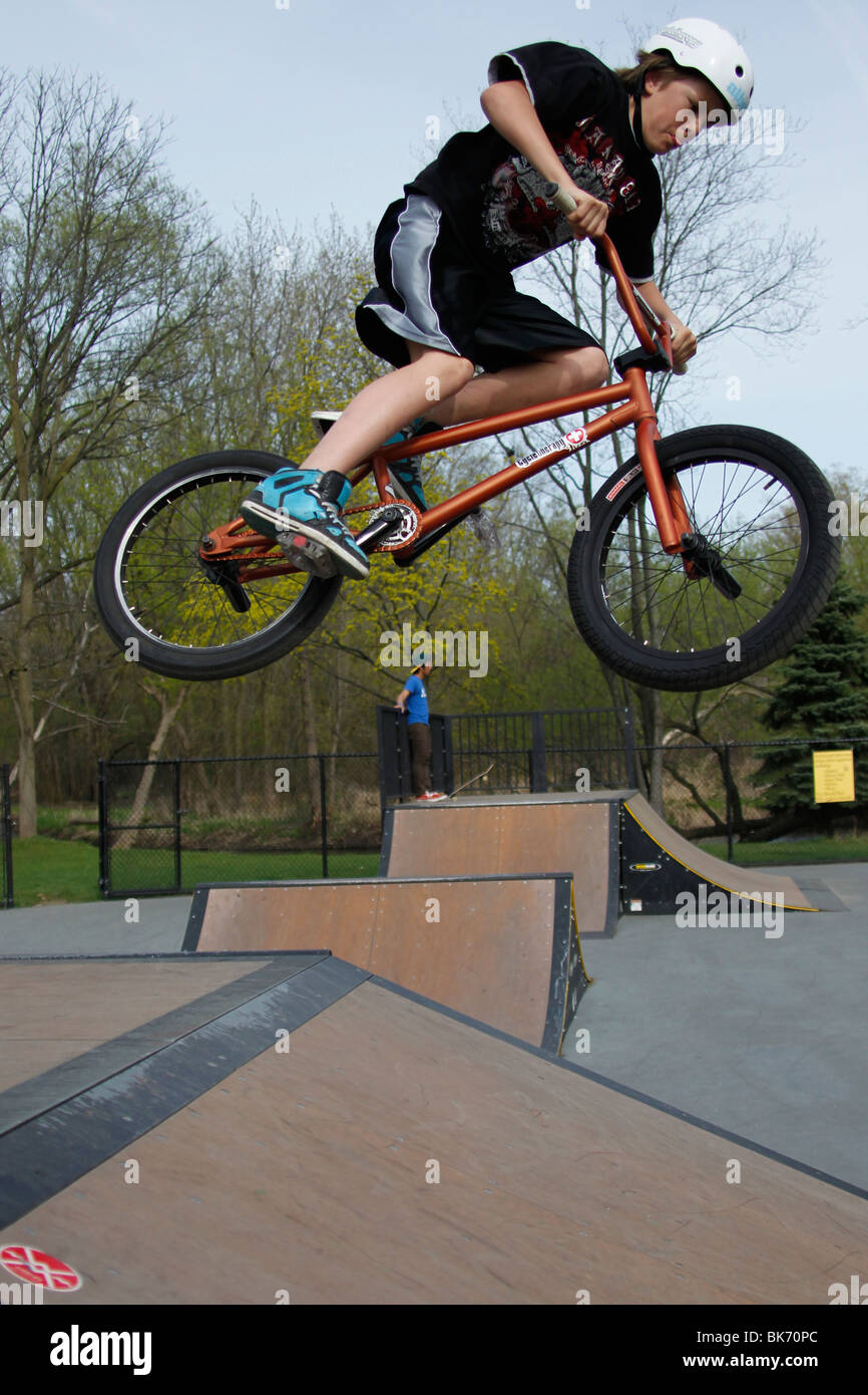 Bicycle rider in mid-air over a ramp at a skatepark Stock Photo - Alamy