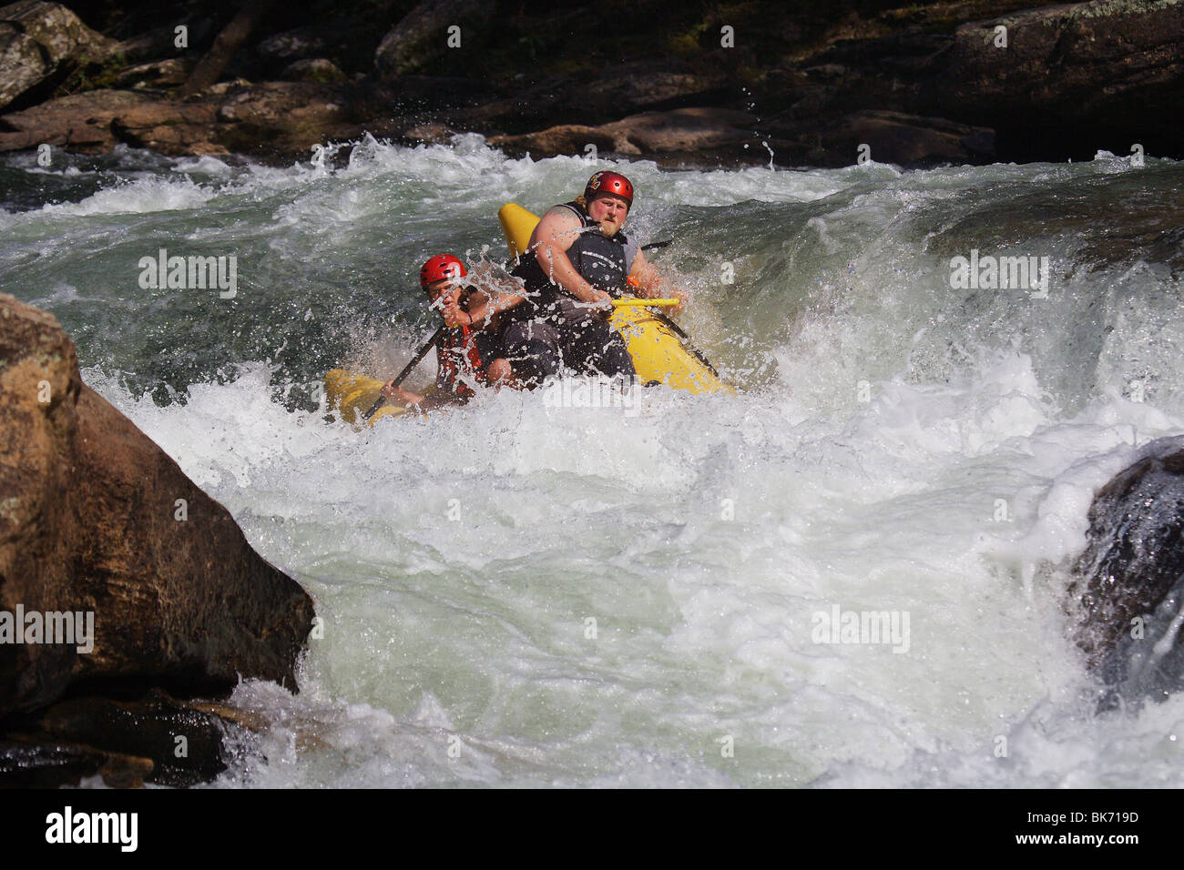 TWO MEN IN PONTOON RAFT BOAT SPLASHING THROUGH RAPIDS BULL SLUICE ...