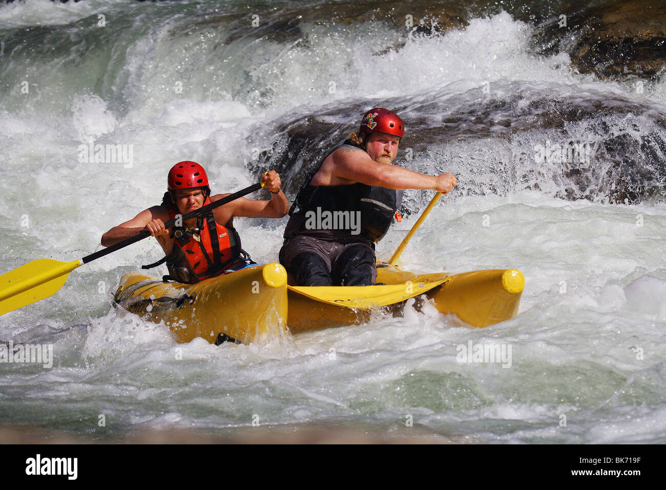 TWO MEN IN PONTOON RAFT BOAT SPLASHING THROUGH RAPIDS BULL SLUICE ...