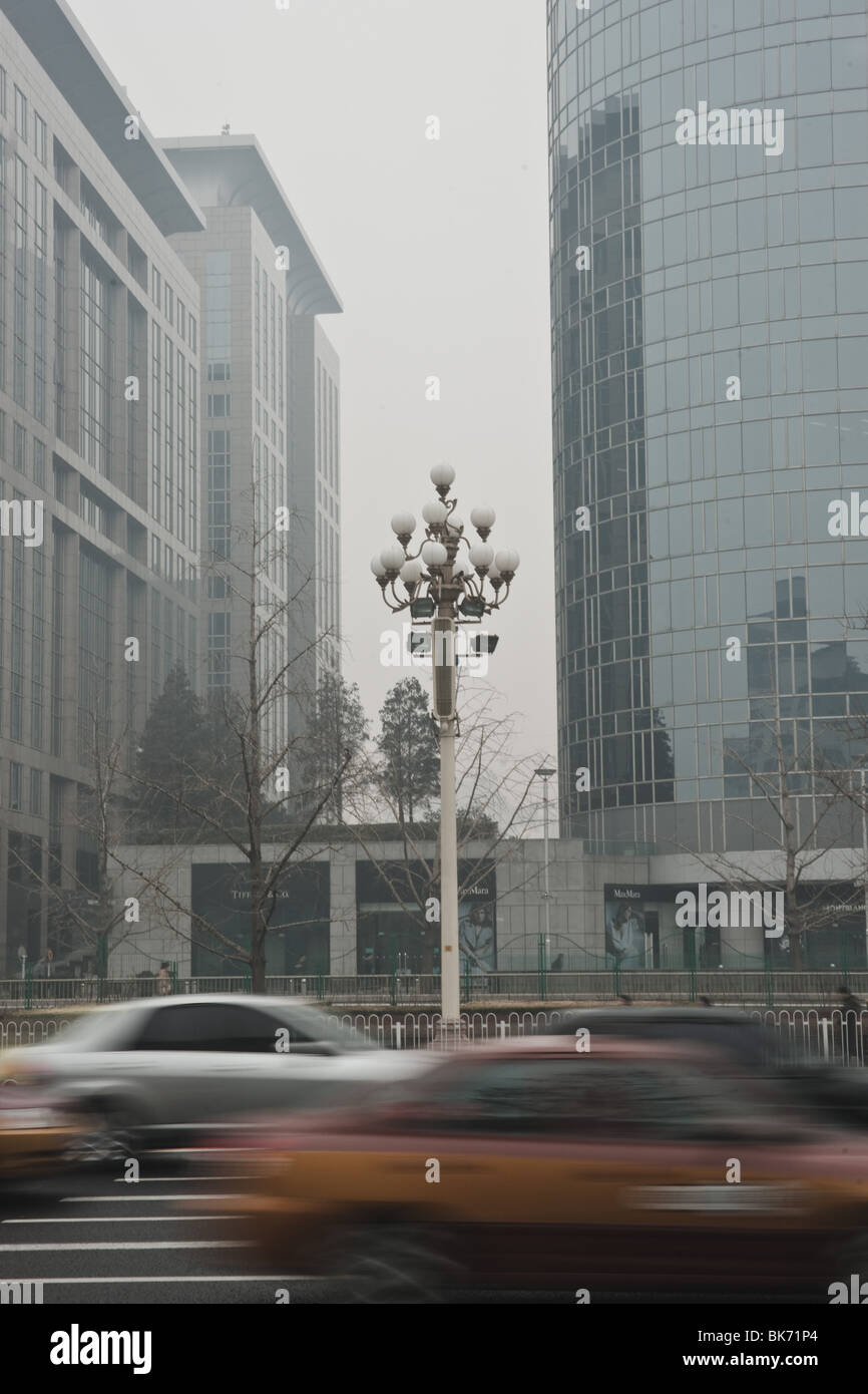 Wide boulevard with street lamp detail and blurred cars in heavy ...