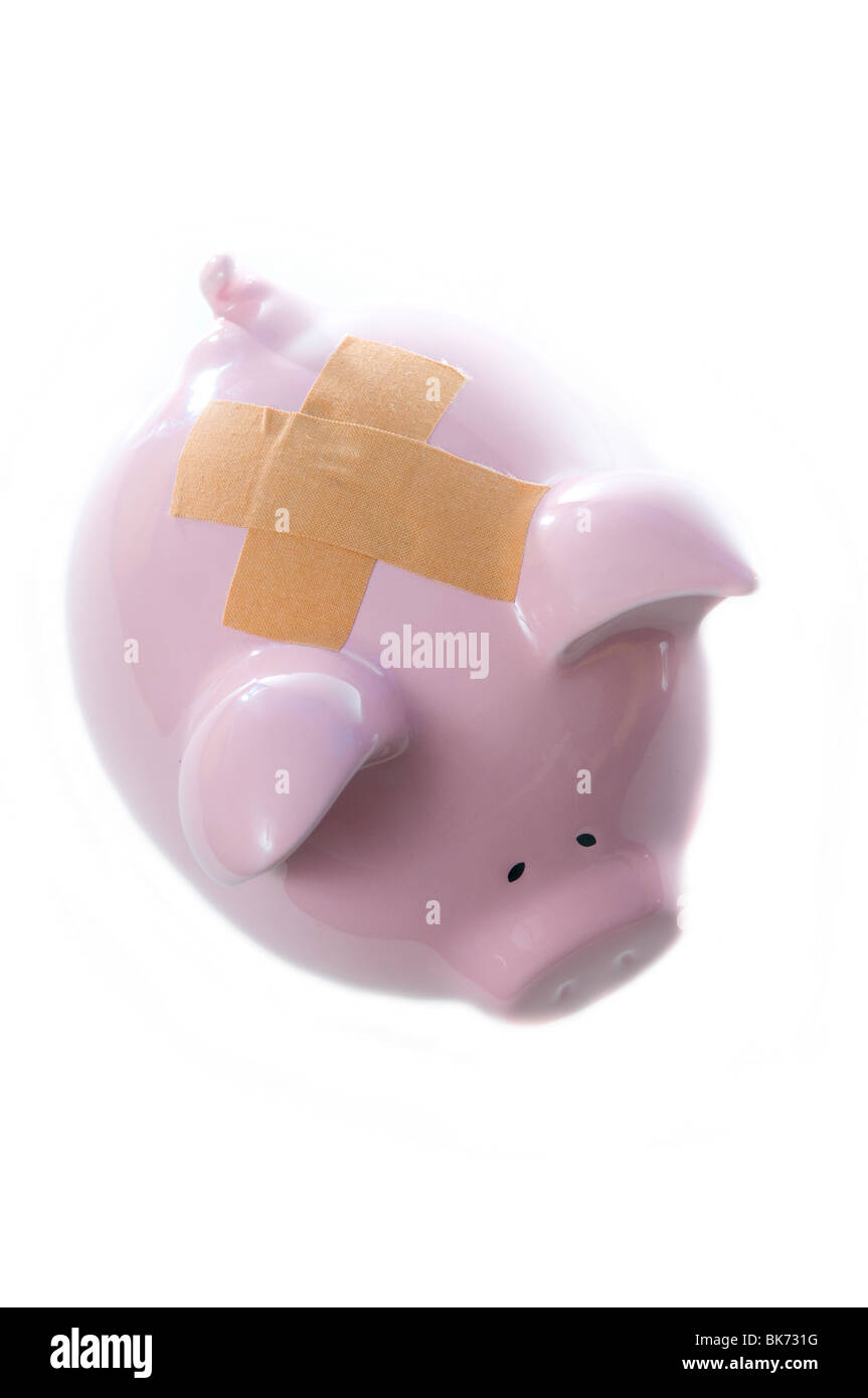 Pink piggy bank with sticking plaster band aid Stock Photo - Alamy