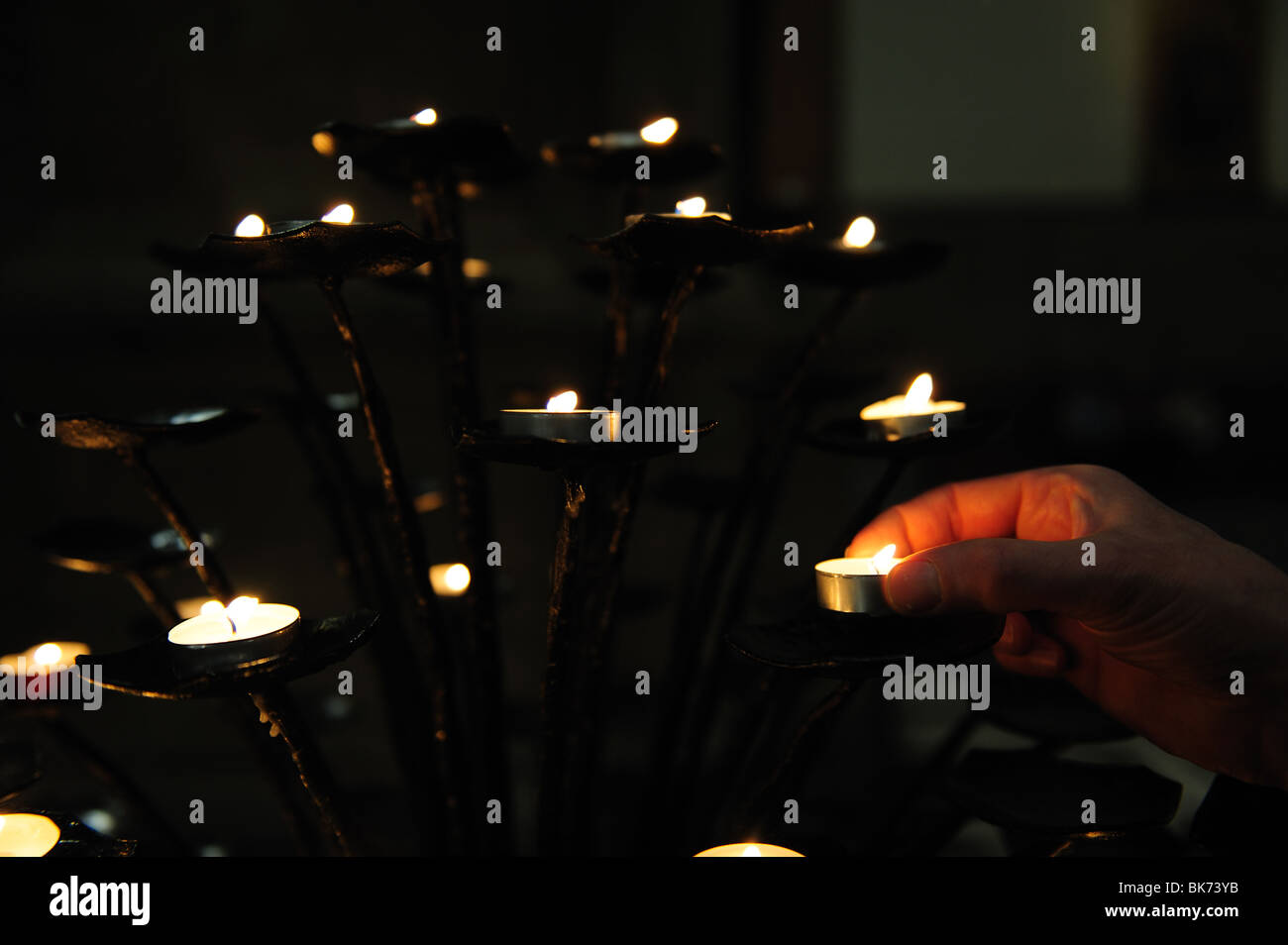 Candles being lit in a church Stock Photo - Alamy