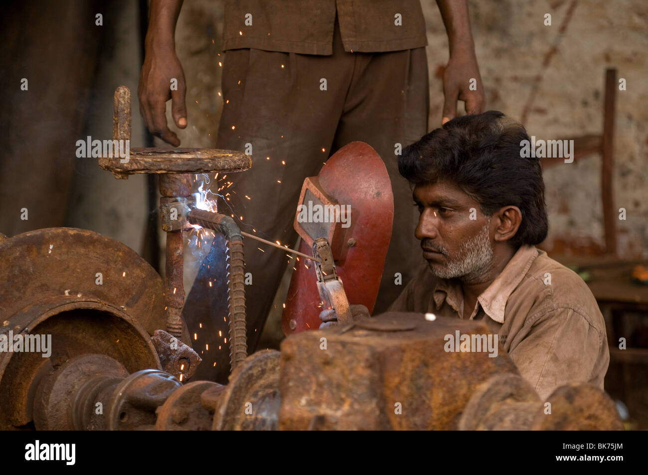 This is an image of an Indian metal worker welding Stock Photo - Alamy