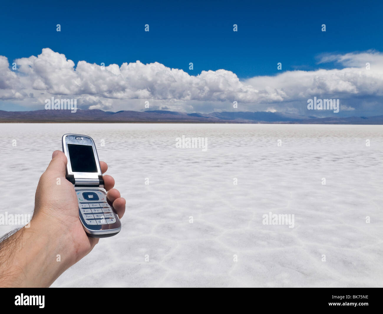 A man holding a cell phone in an open salt mine Stock Photo - Alamy