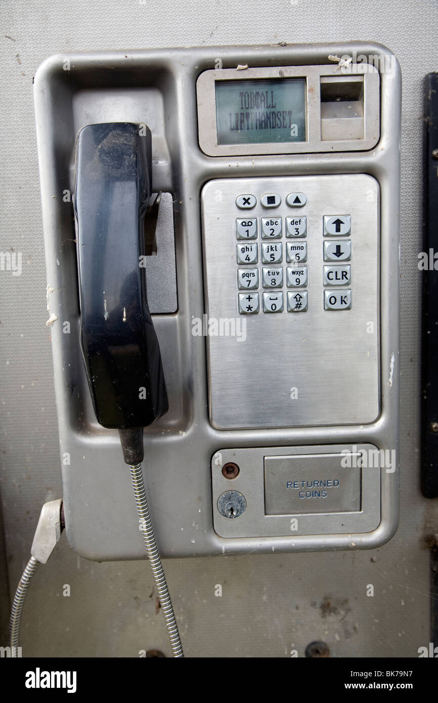 Phone in telephone box close up Stock Photo - Alamy