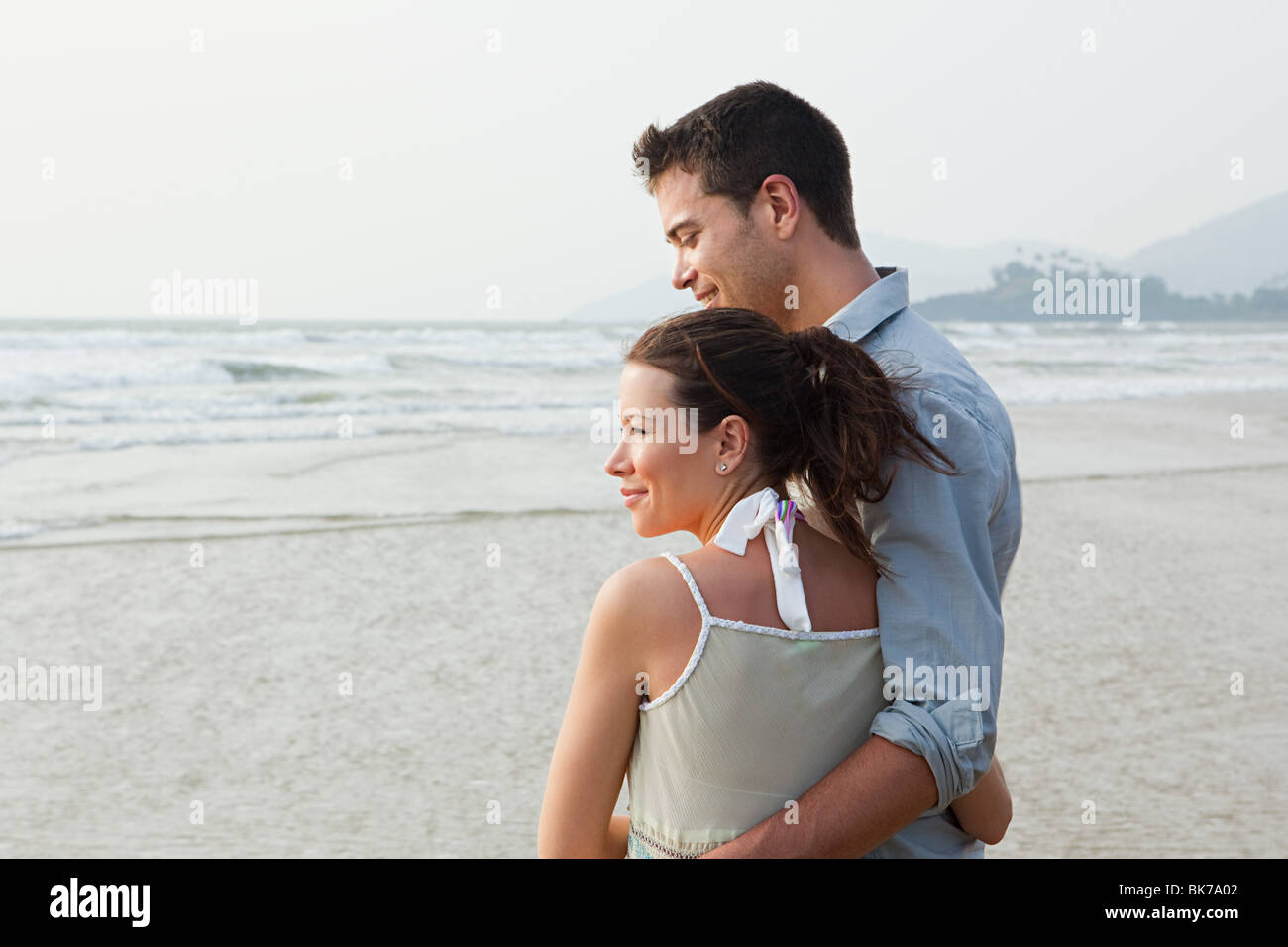 Couple by the ocean Stock Photo - Alamy