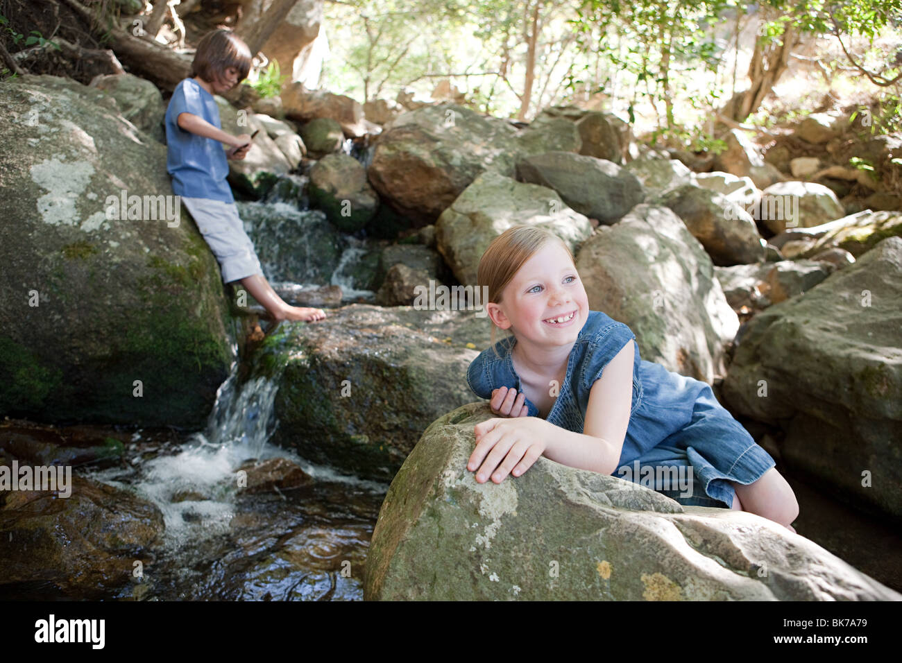 Two children playing on rocks hi-res stock photography and images - Alamy
