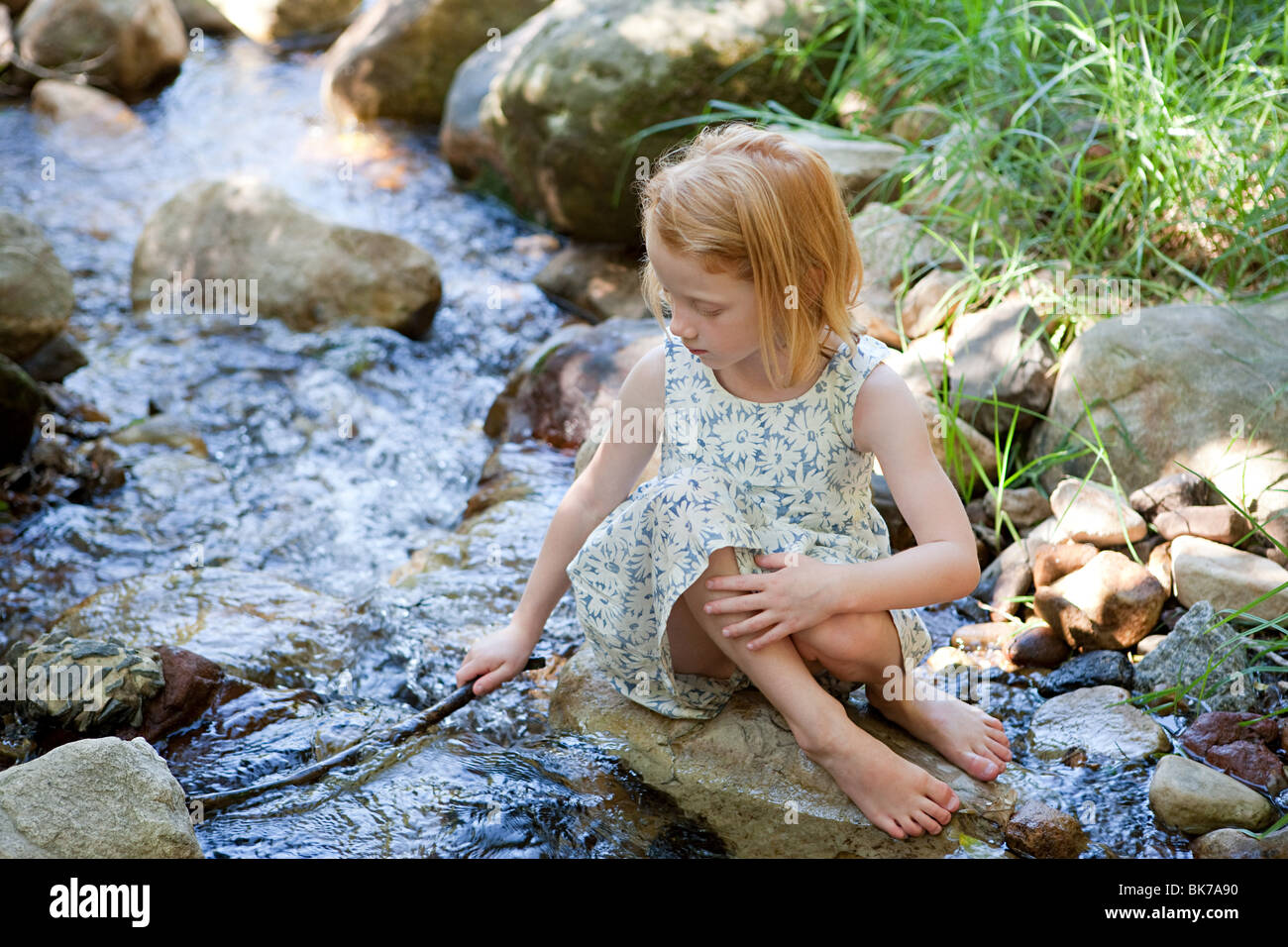 Girl playing in river Stock Photo - Alamy