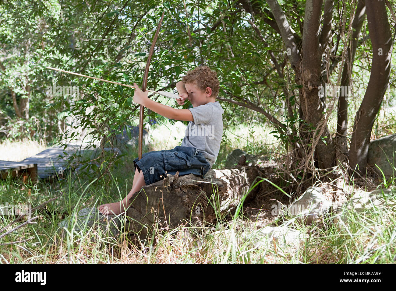 Boy with bow and arrow Stock Photo - Alamy