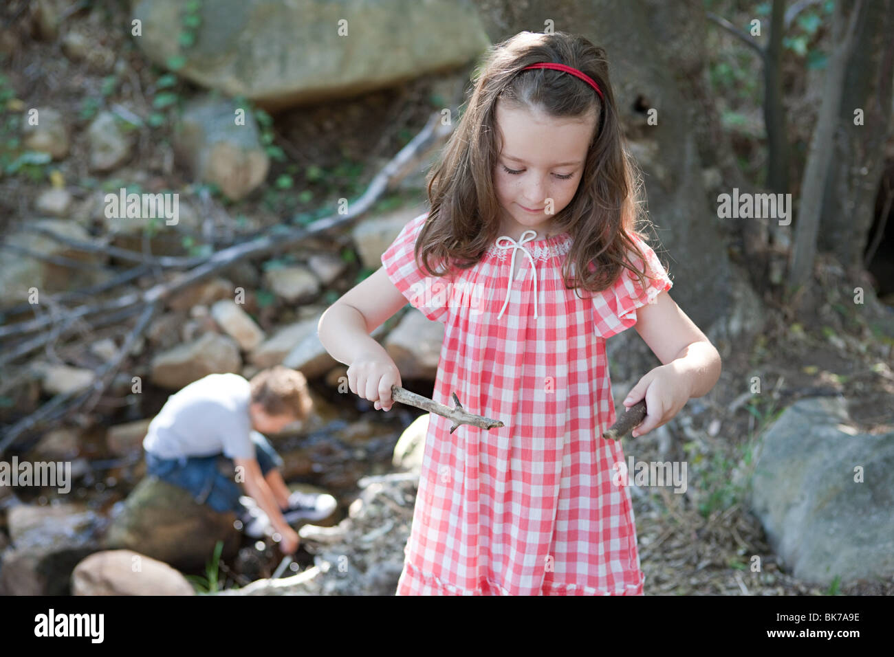 Girl holding sticks Stock Photo - Alamy