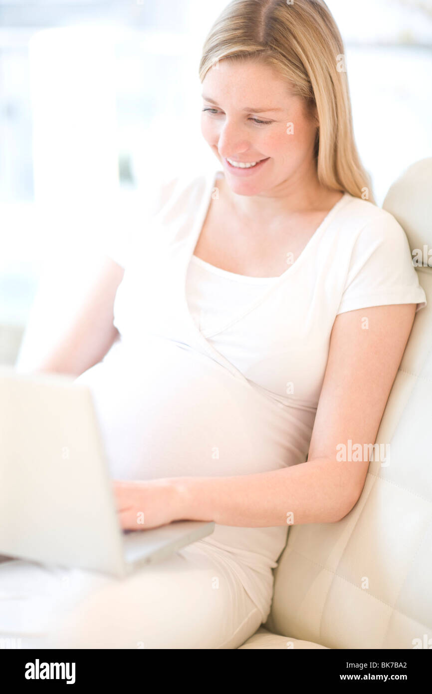 Pregnant woman using a laptop Stock Photo - Alamy