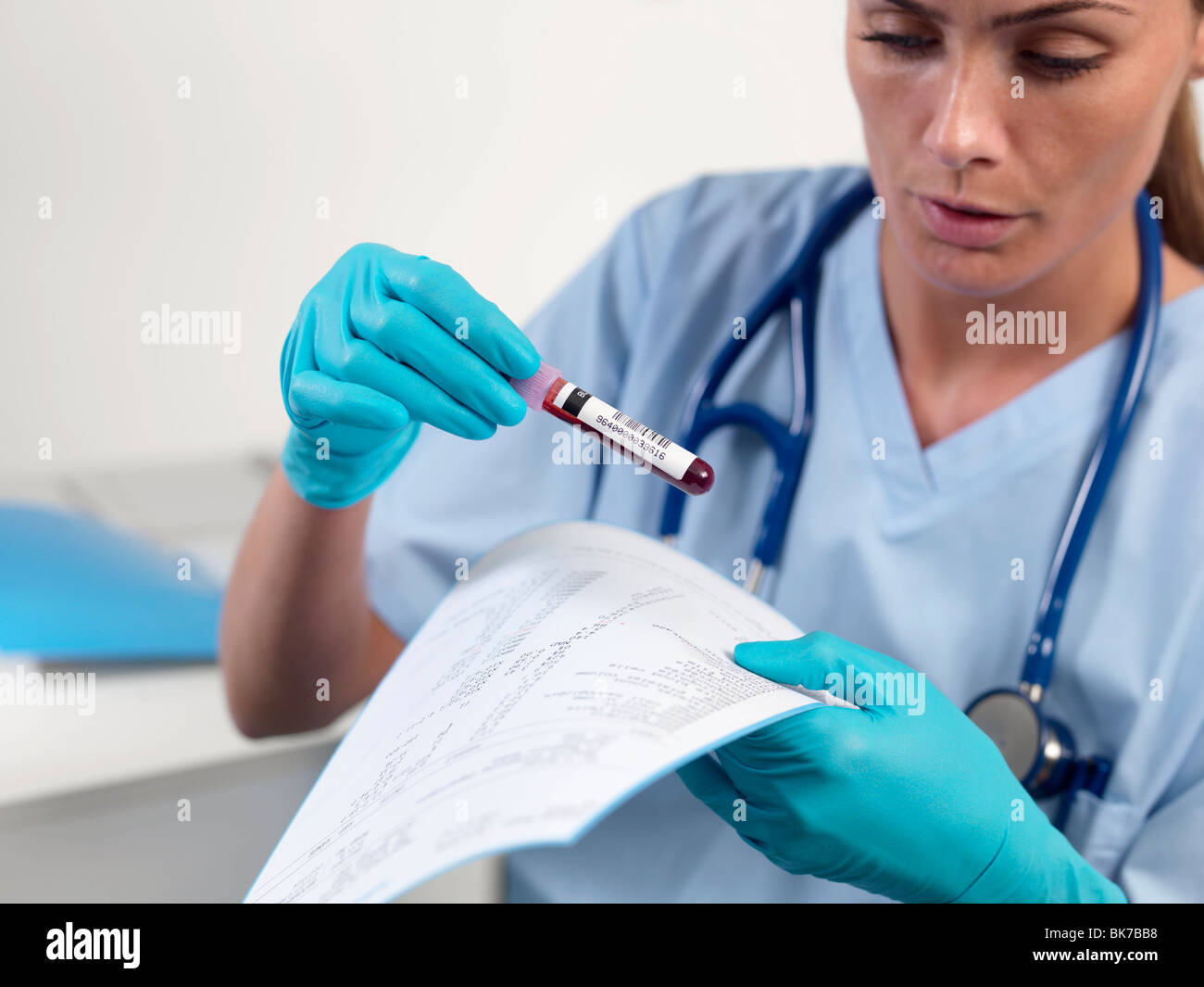 Doctor checking a blood sample Stock Photo - Alamy
