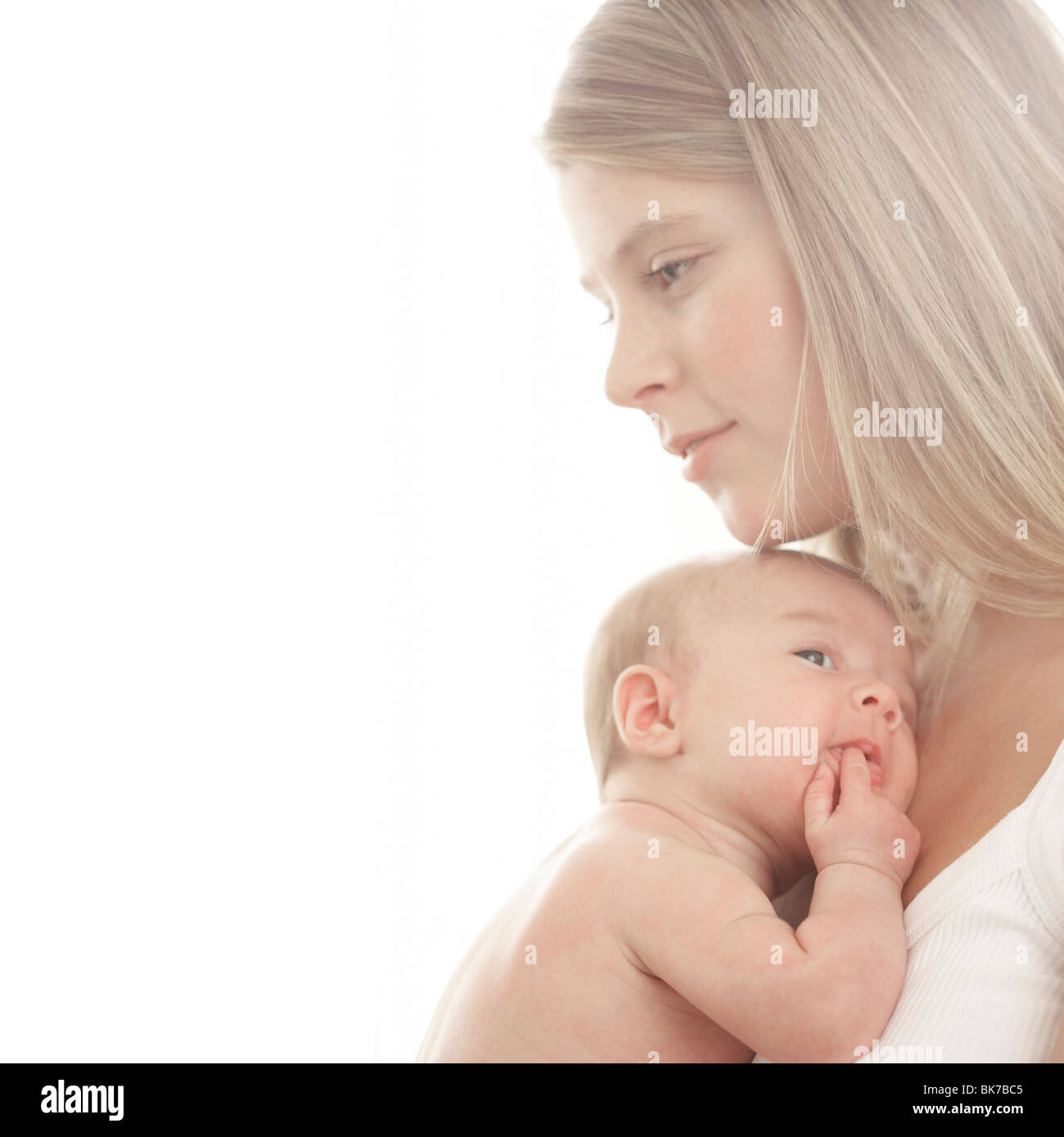 Baby being cuddled by her mother Stock Photo - Alamy