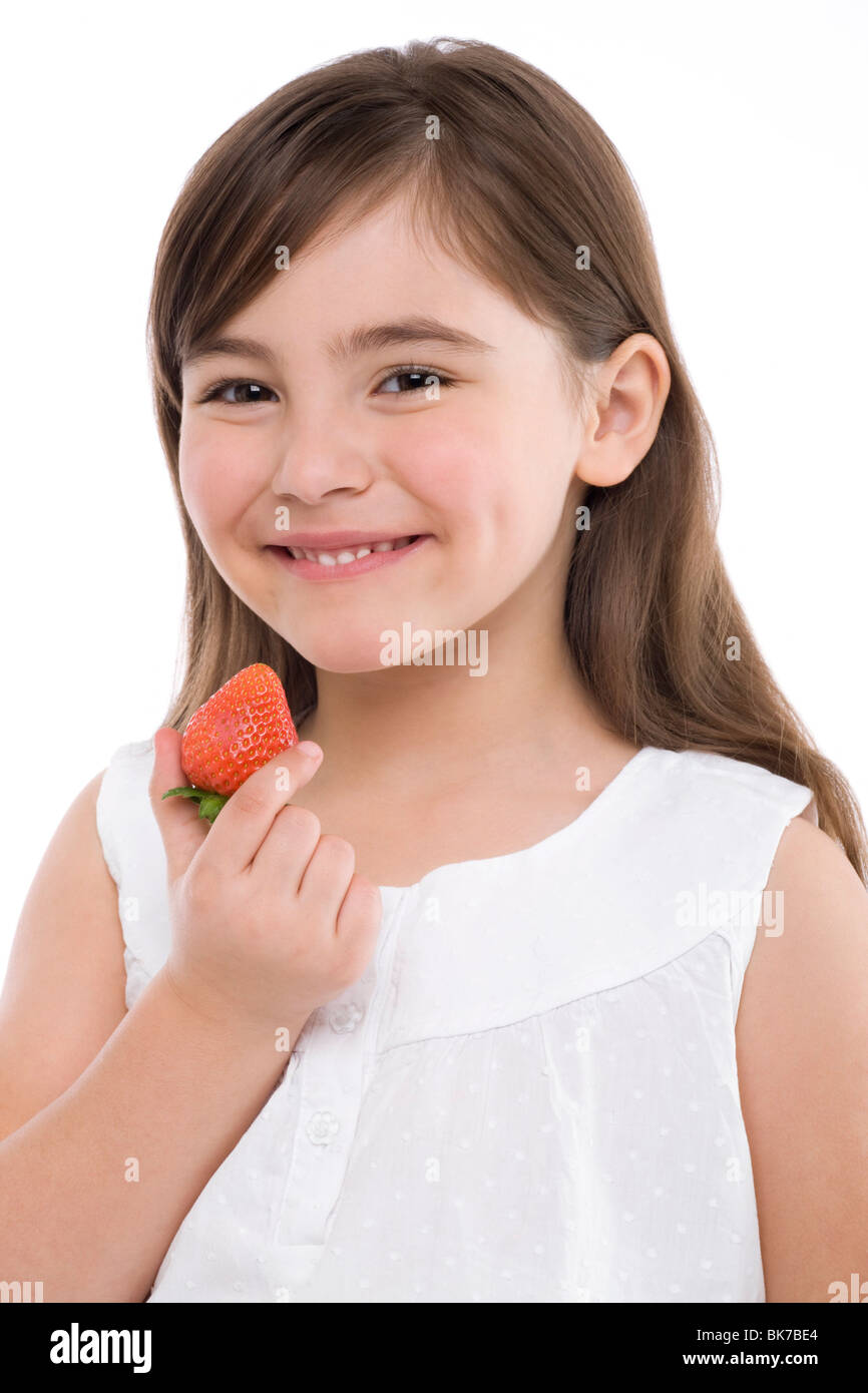 Girl eating a strawberry Stock Photo - Alamy