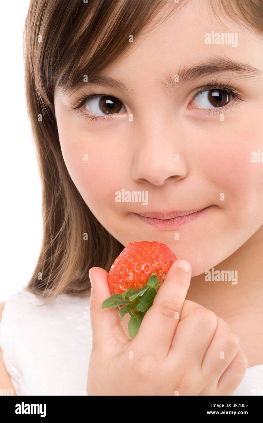 Girl eating a strawberry Stock Photo - Alamy