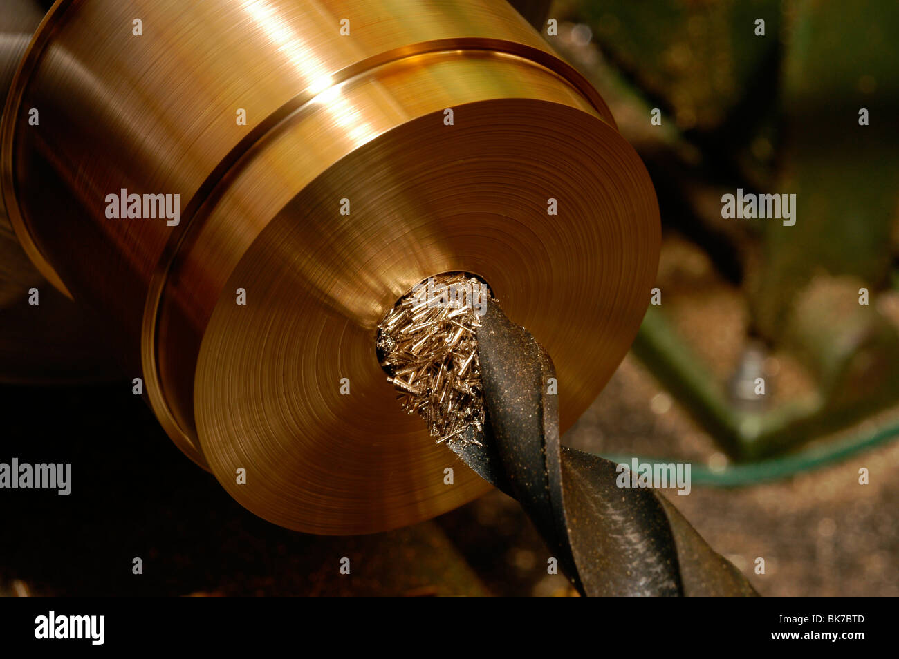 drilling a piece of brass bar in a lathe Stock Photo - Alamy