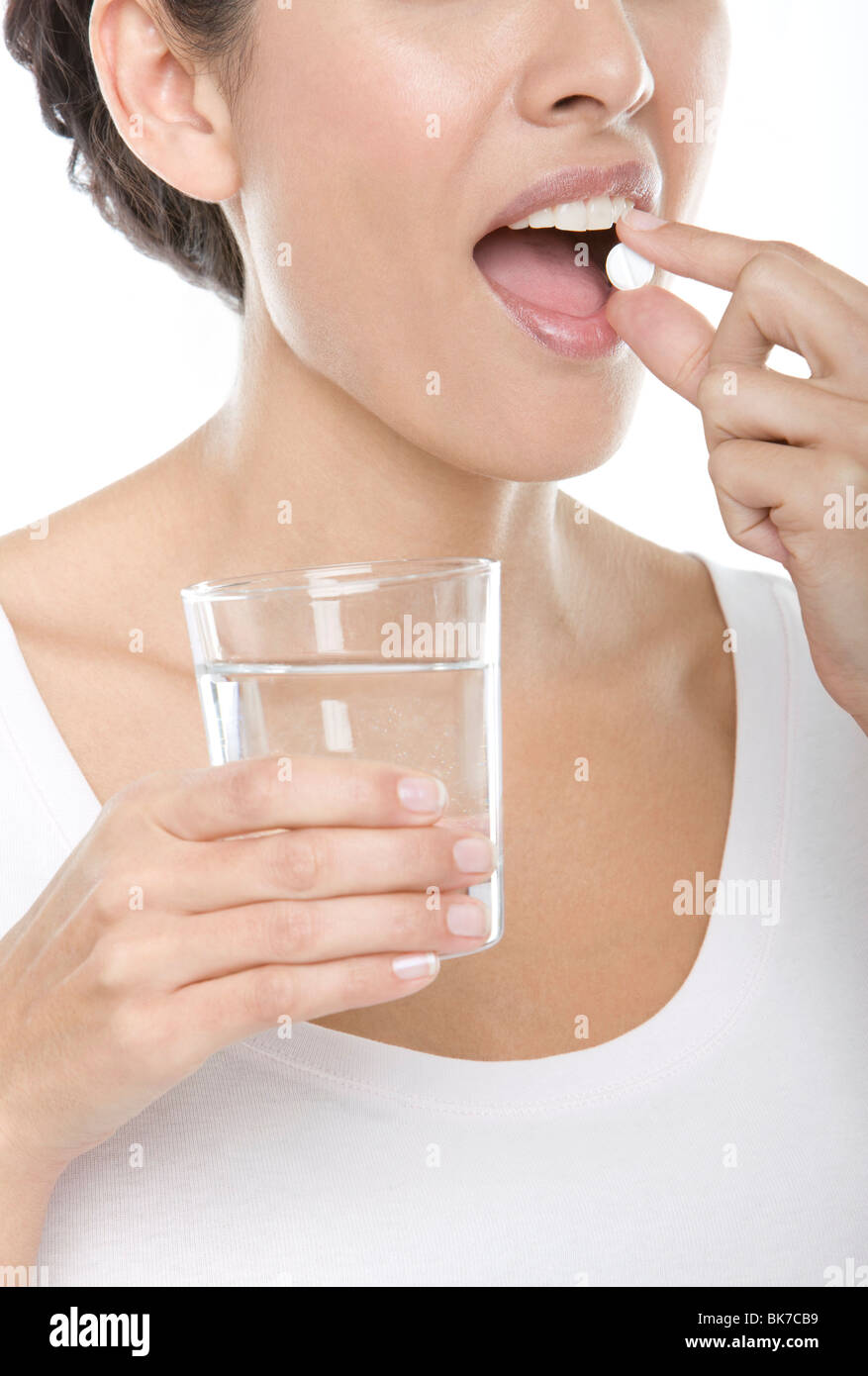 Taking a tablet Stock Photo - Alamy