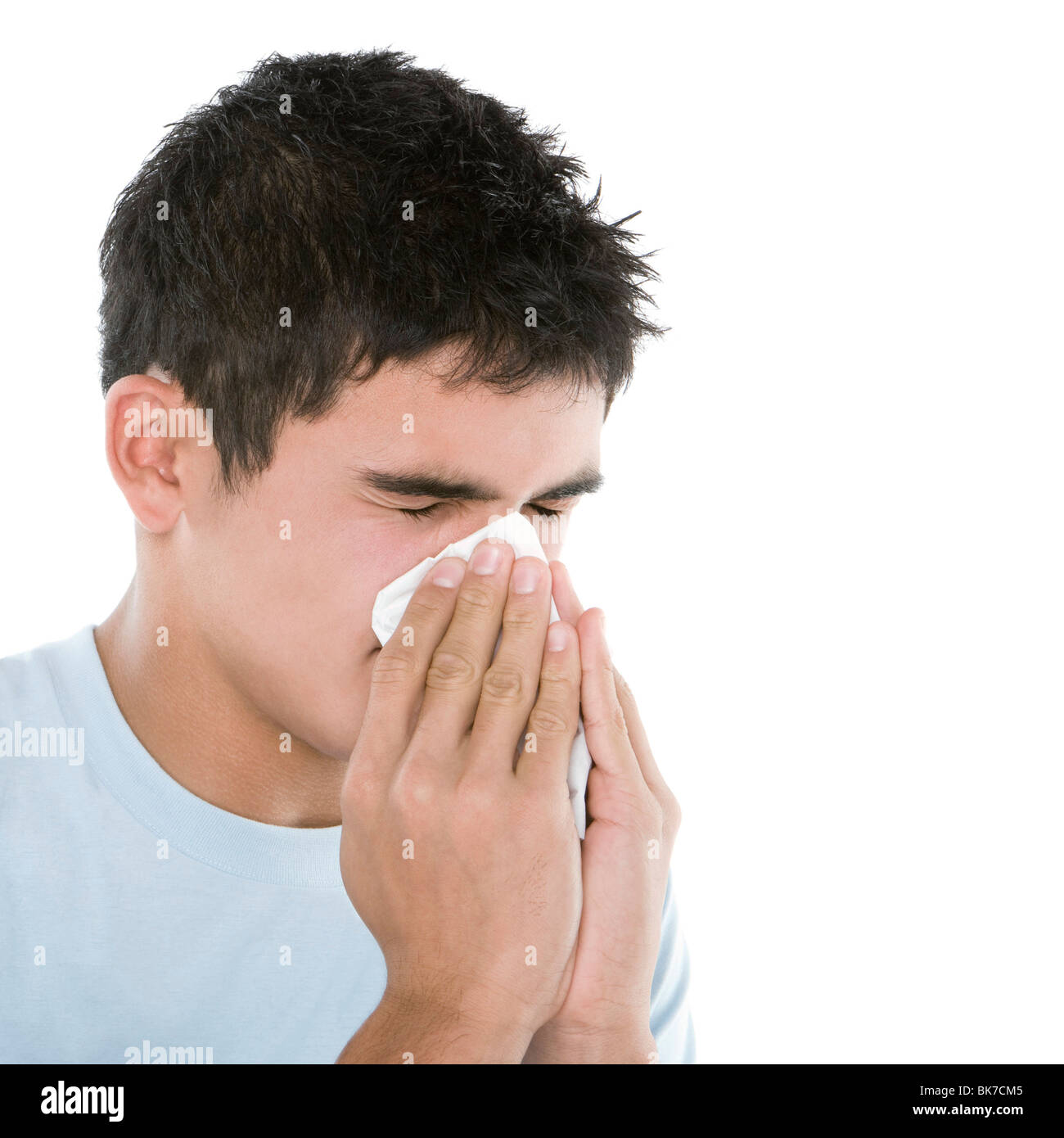 Teenage boy sneezing Stock Photo - Alamy