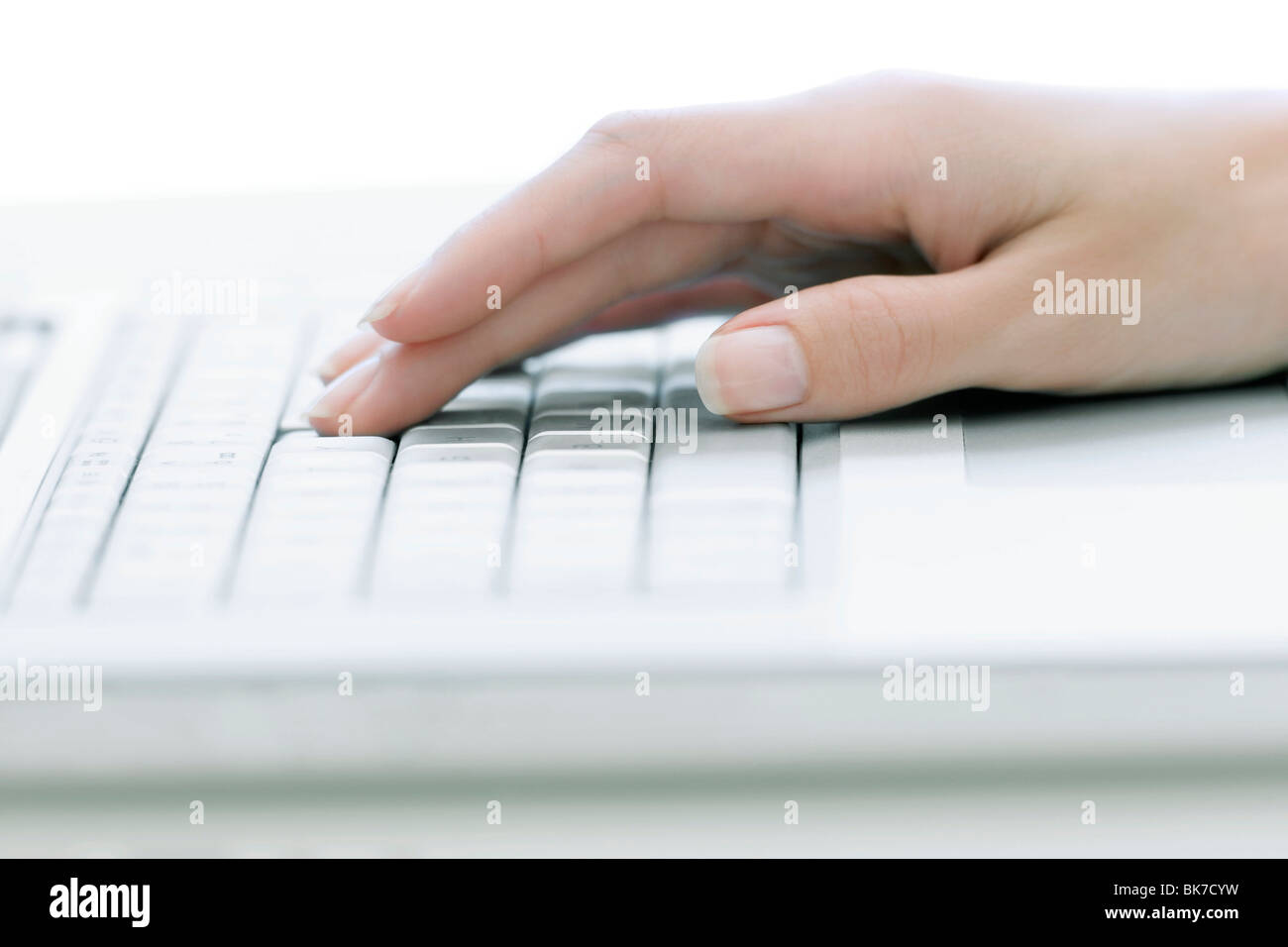 Typing on a laptop Stock Photo - Alamy
