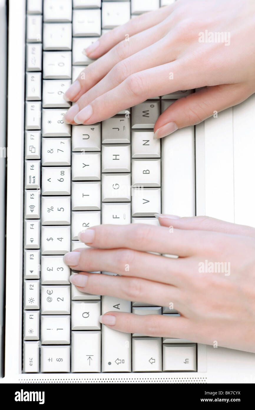 Typing on a laptop Stock Photo - Alamy