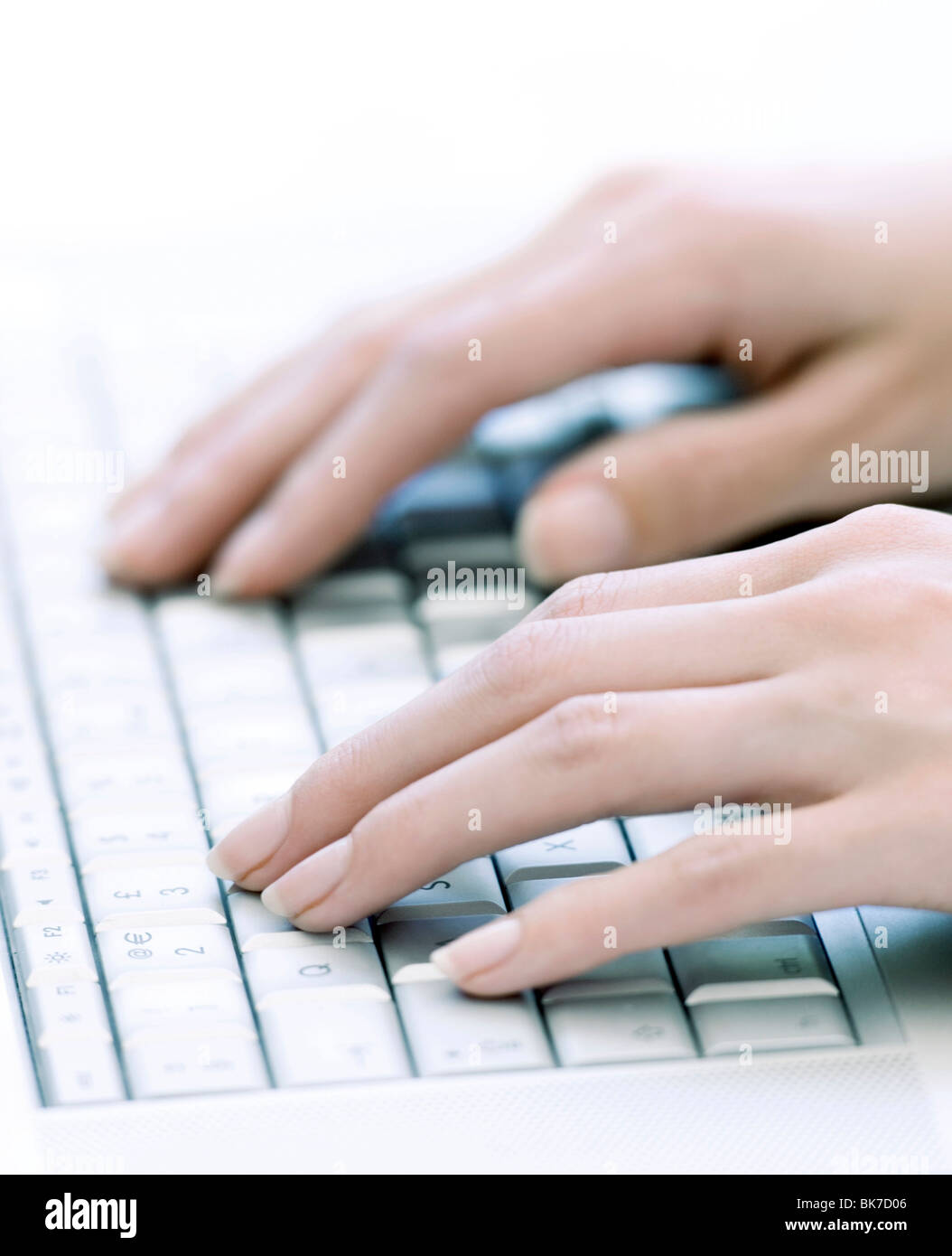 Typing on a laptop Stock Photo - Alamy
