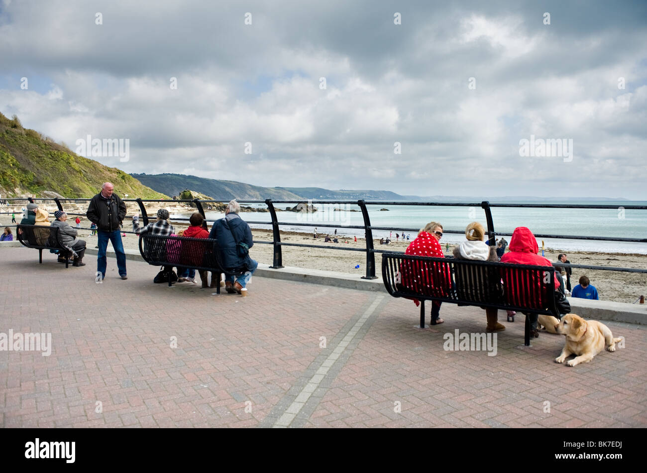 Elderly tourists sitting on the seafront at Looe in Cornwall. Photo by ...