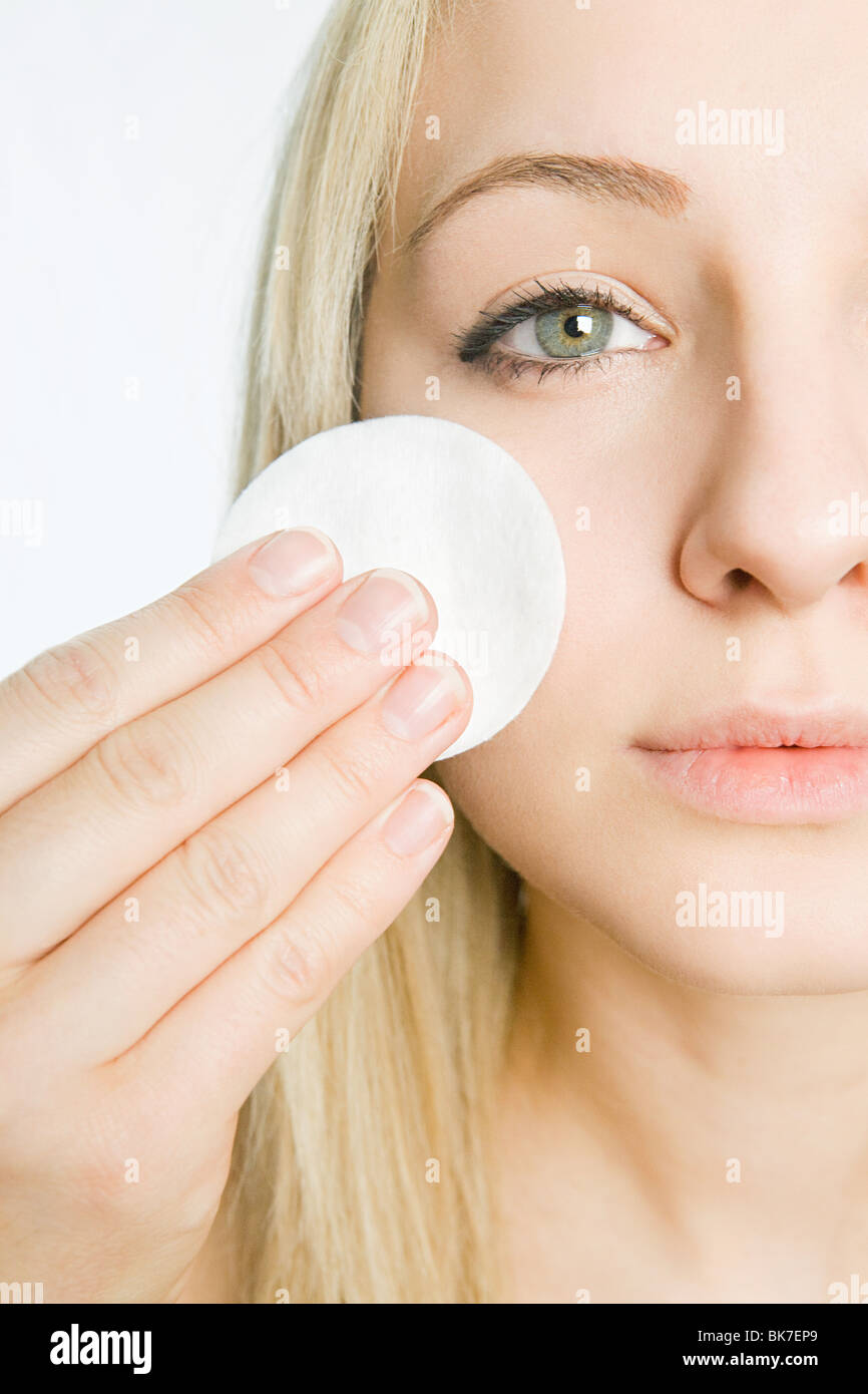 Young woman cleansing face Stock Photo - Alamy