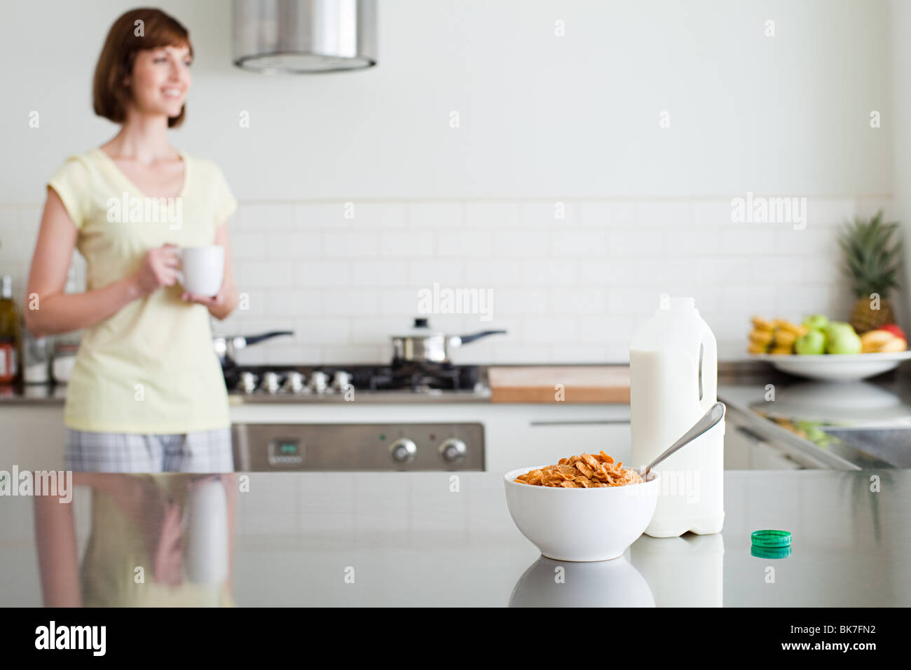 Woman in kitchen at breakfast Stock Photo - Alamy