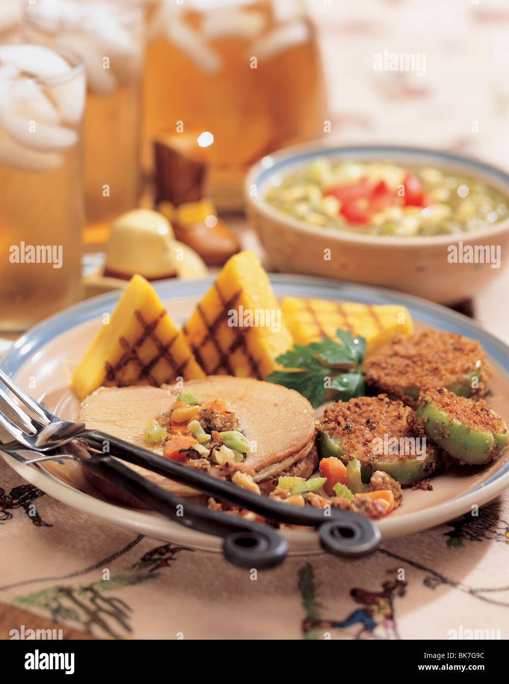 Pork, peppers, corn bread, soup and iced tea in a warm southwestern ...