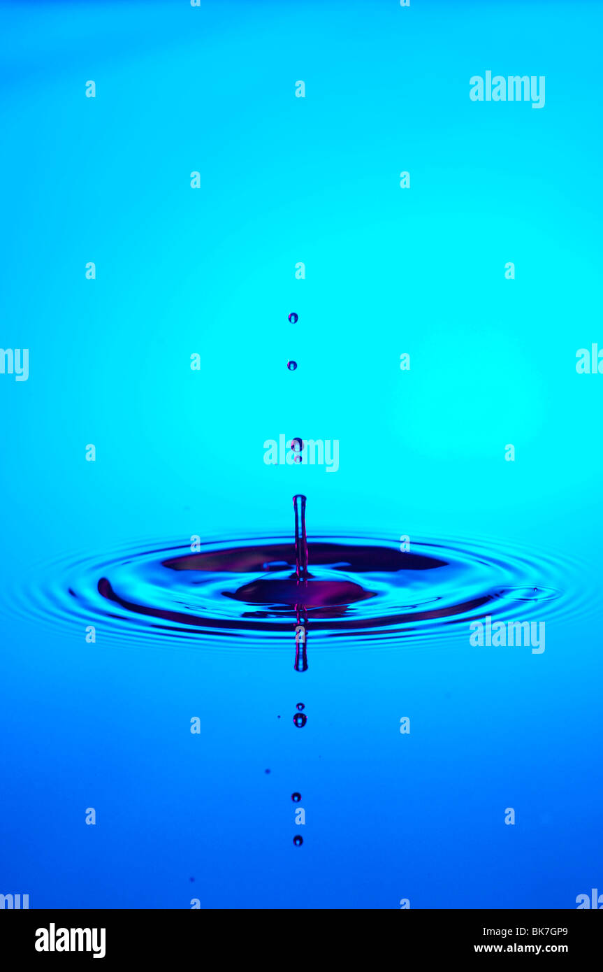 vertical blue/magenta sidelight water drop Stock Photo - Alamy