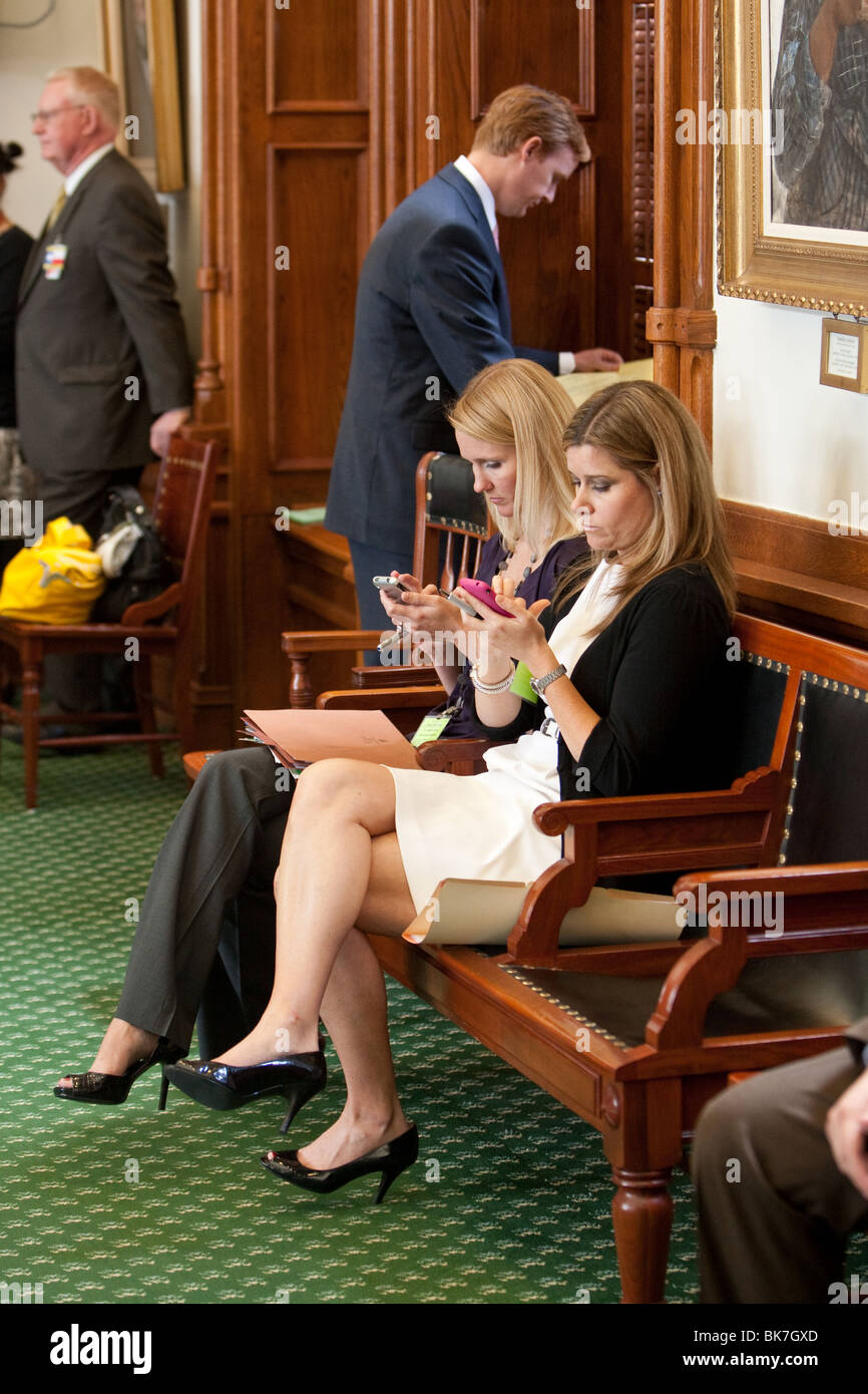 Female Senate staffers type text messages into their cell phones during ...