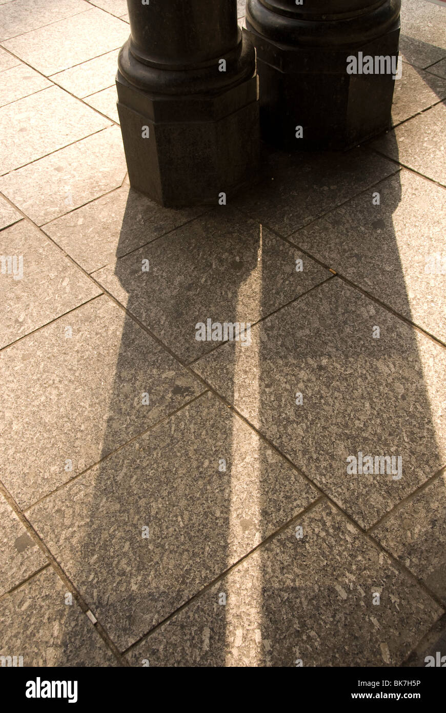 shadow of two pillars on the pavement or sidewalk Stock Photo - Alamy