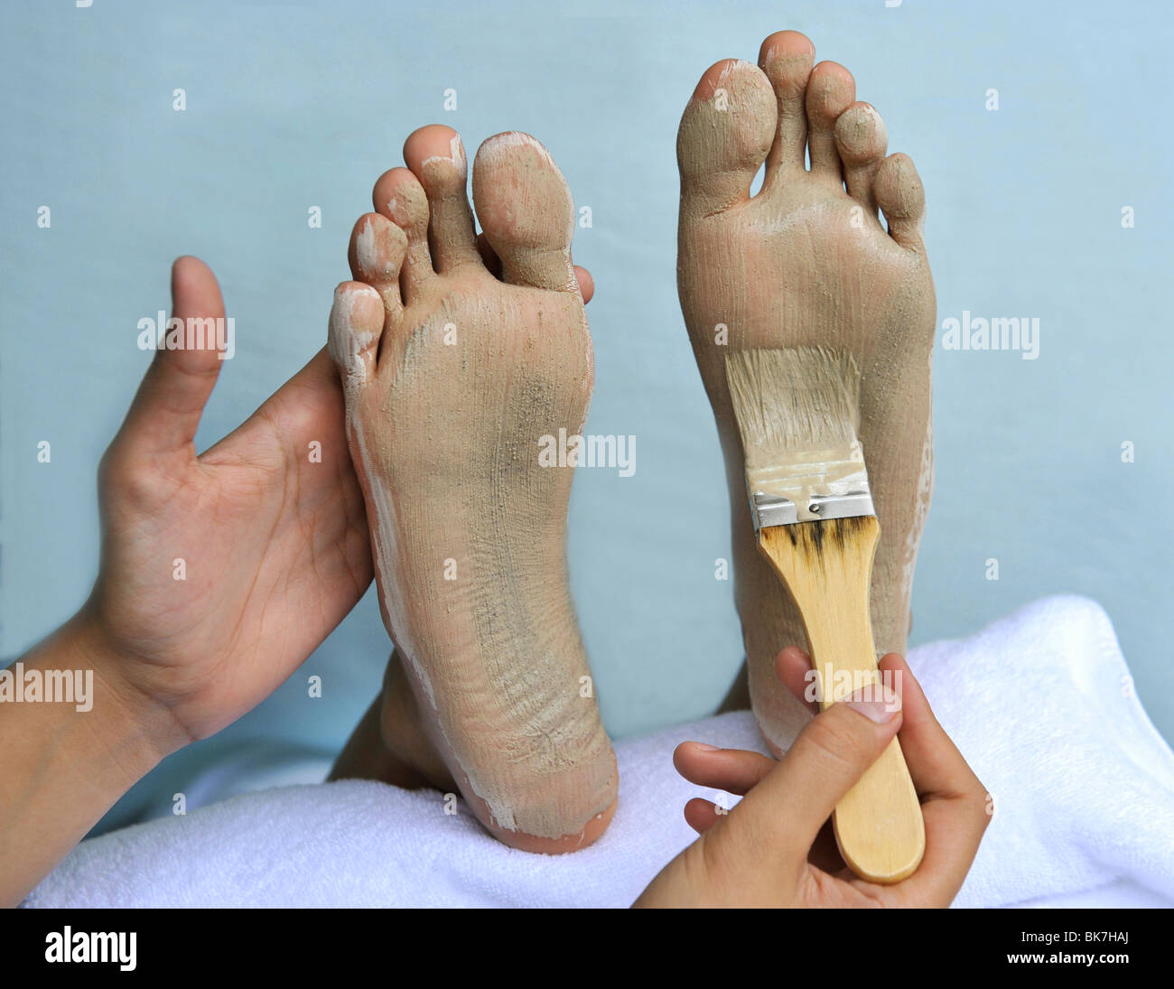 Applying foot clay mask Stock Photo - Alamy
