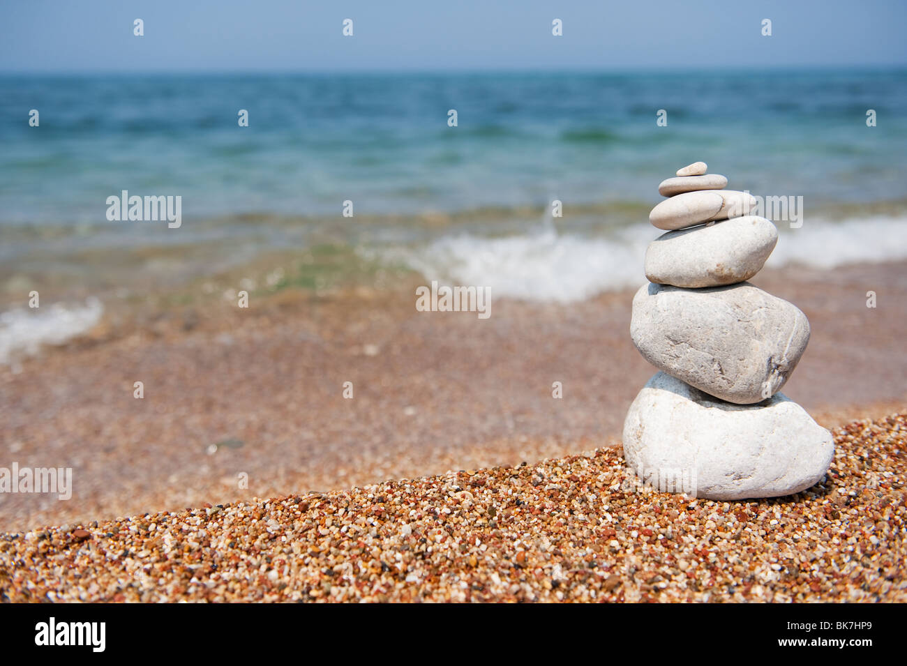 Stacked nature stones at the beach in landscape Stock Photo - Alamy