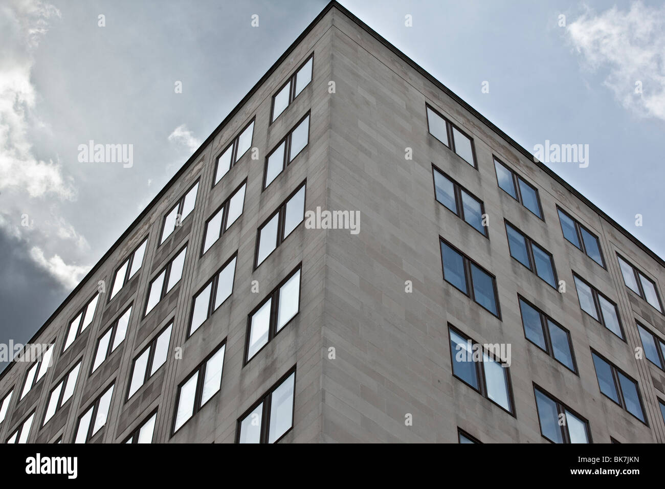 corner view of a building with windows reflecting clouds Stock Photo ...