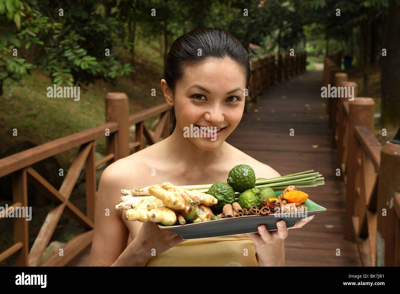 Girl holding a tray full of ingredients for Jamu, the Indonesian herbal ...