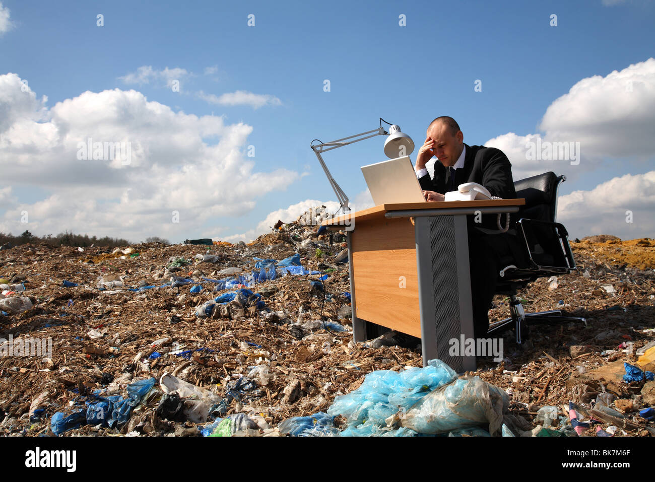 Office worker at desk at British landfill site Stock Photo - Alamy