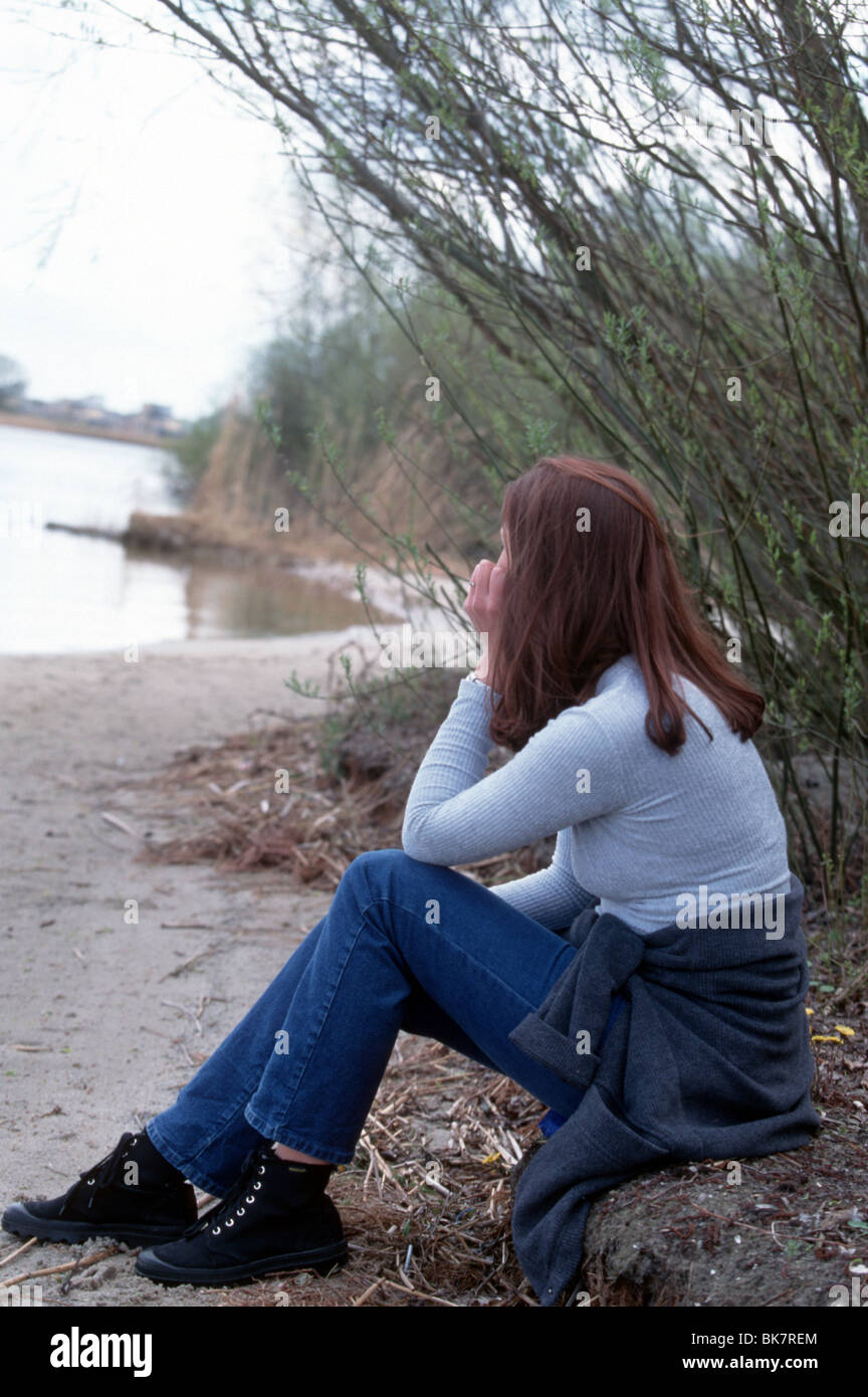 Woman sitting back view outdoors Stock Photo - Alamy