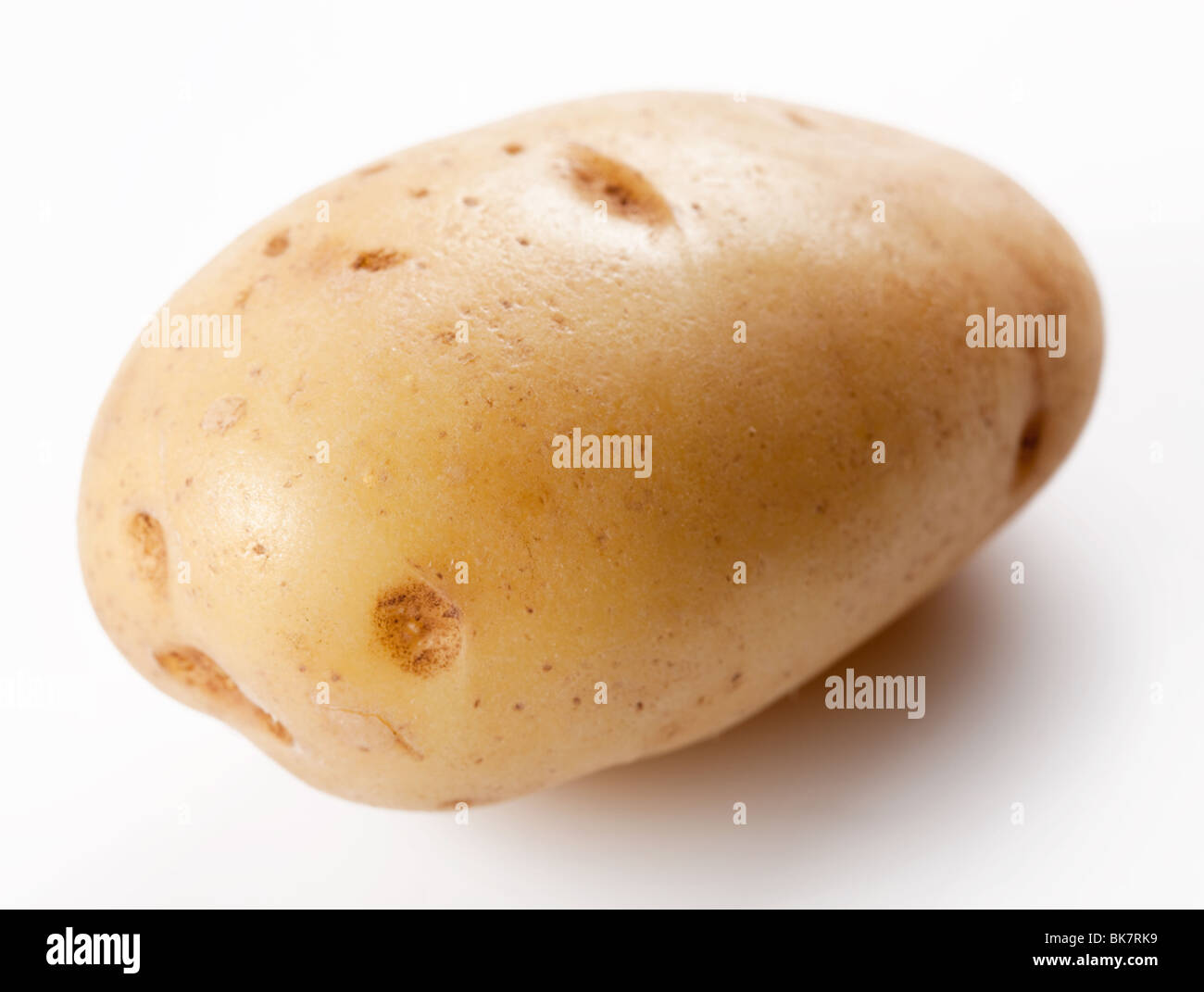 Yellow potato on a white background Stock Photo - Alamy