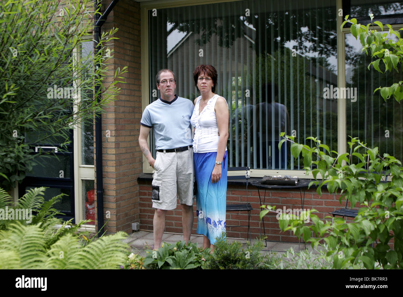 Couple posing in front house hi-res stock photography and images - Alamy