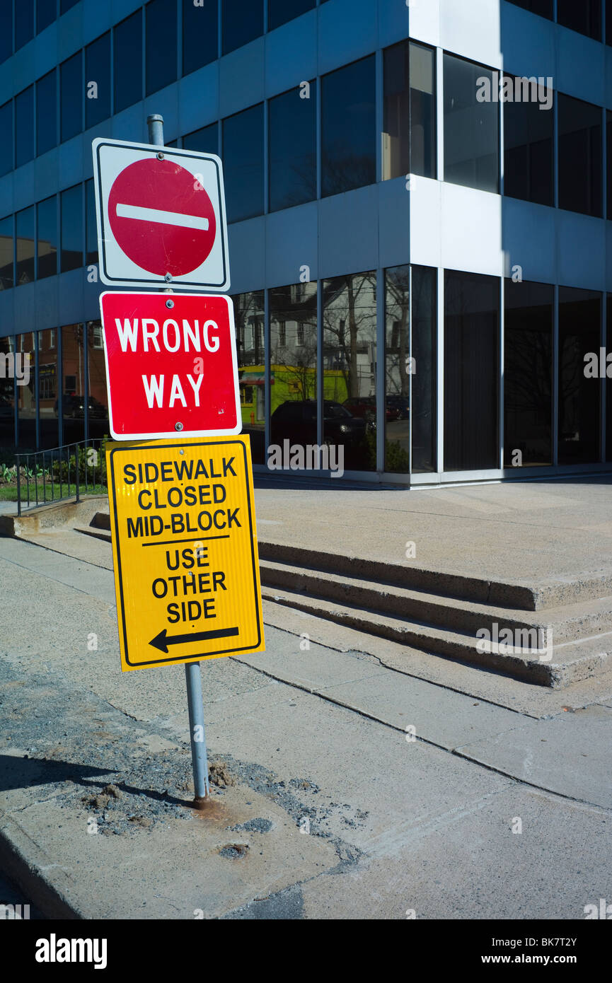 Wrong way and sidewalk closed signs on downtown street by office ...