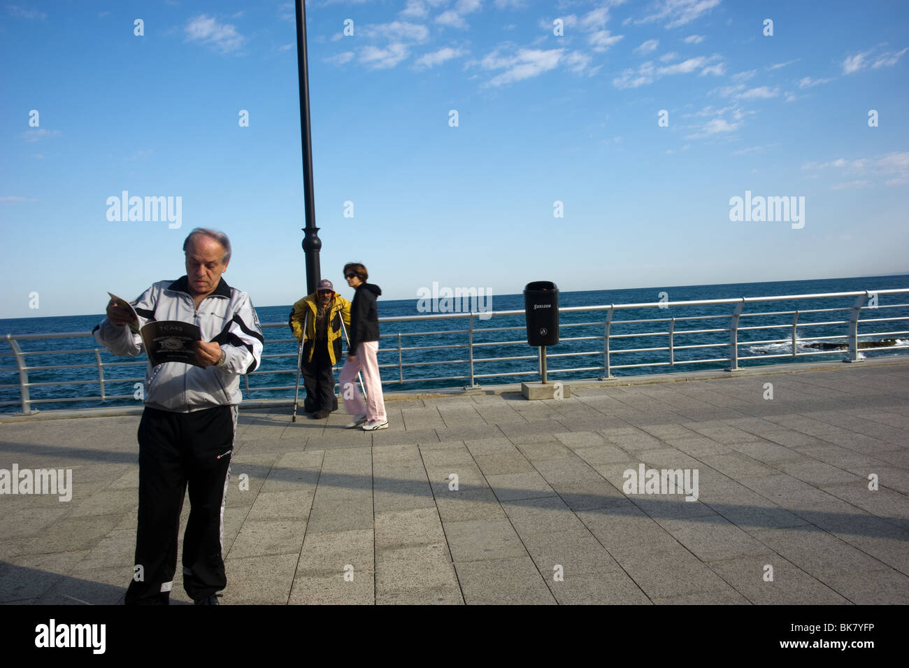 A resident of Beirut read magazine on the cornice of Beirut Lebanon ...
