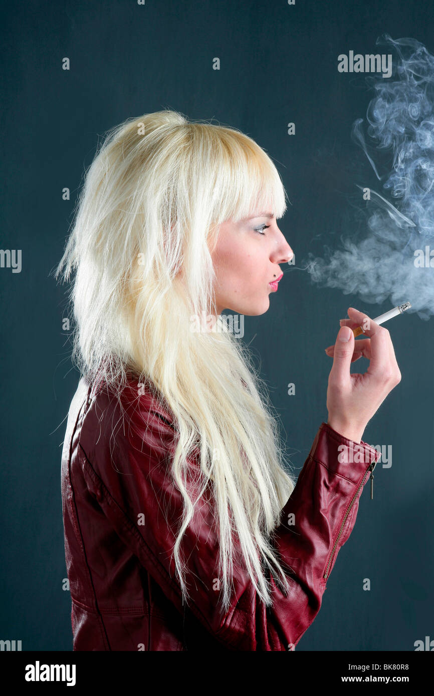 blonde smoking cigarette young fashion girl grunge background Stock ...