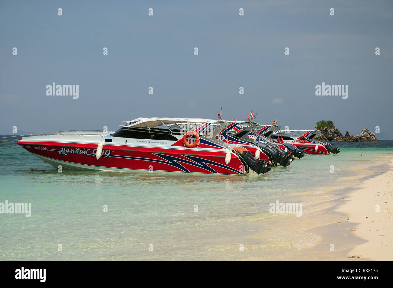 Speed boats beside tropical beach Stock Photo - Alamy