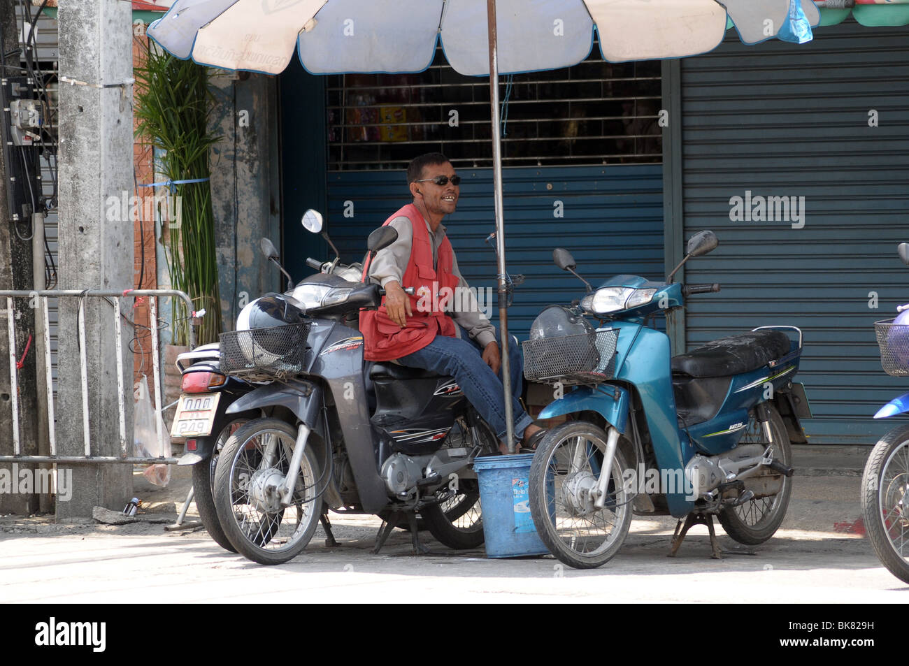 Motorcycle taxi driver in Thailand Stock Photo - Alamy