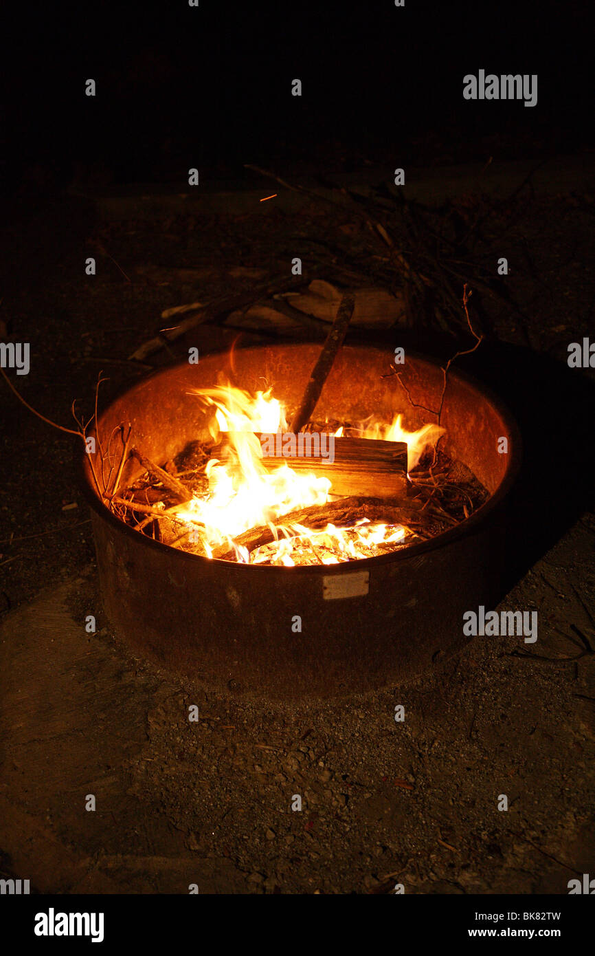FIRE BURNING IN CAMPSITE FIRE RING FIRE SAFETY Stock Photo - Alamy