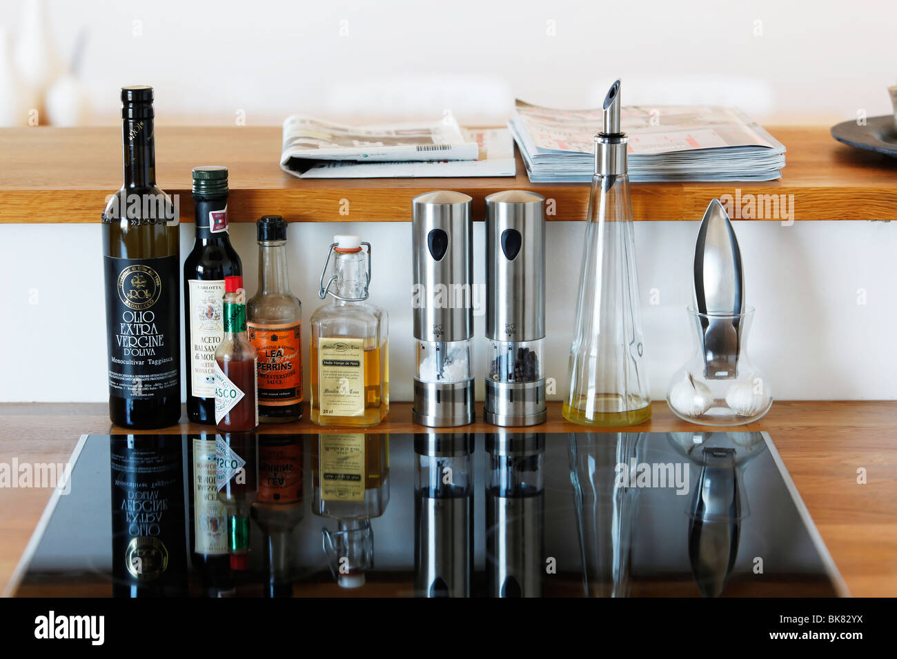 condiments on a kitchen counter top with reflection in glass cooking ...