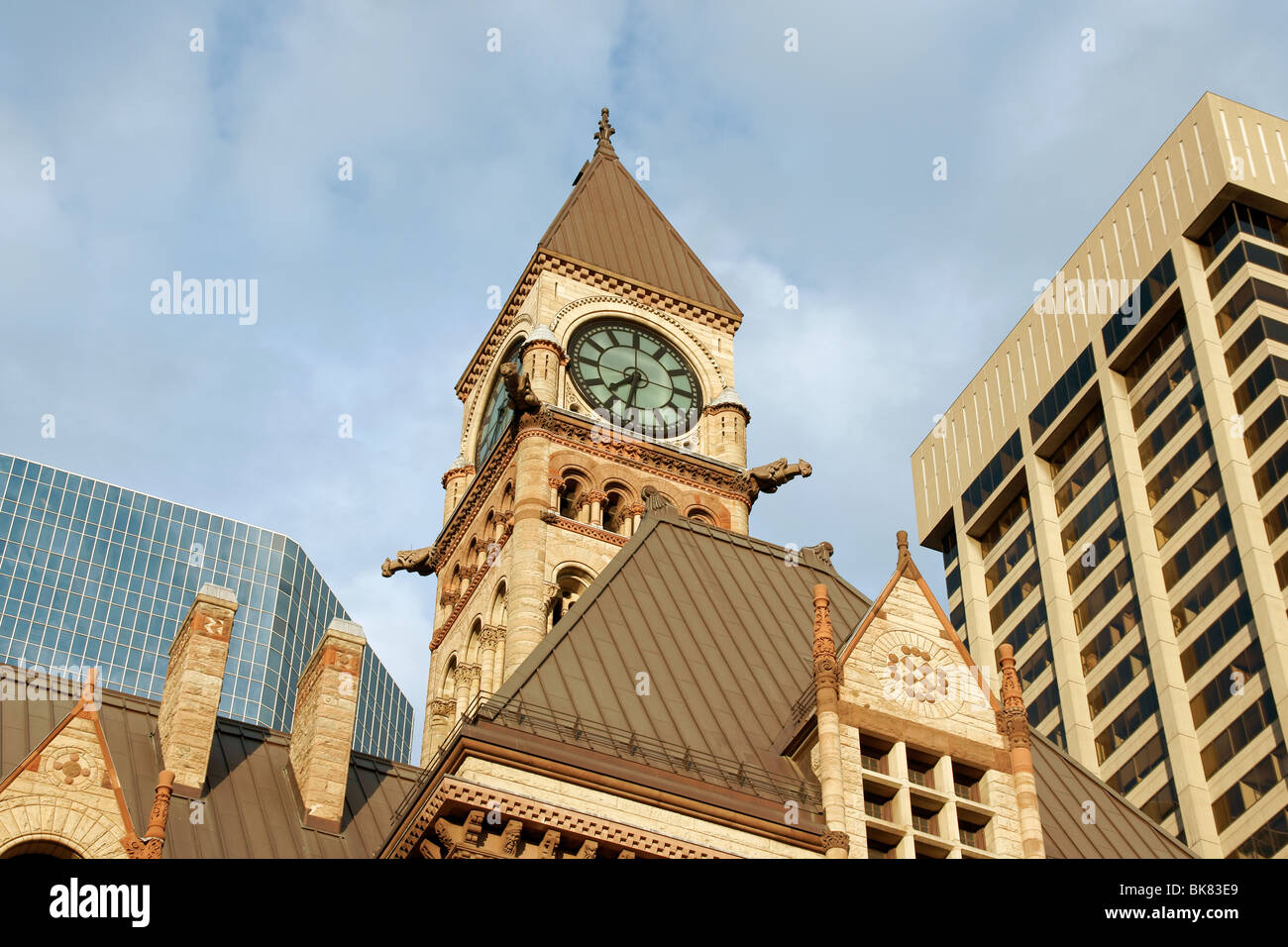 Old city hall of toronto in neo-gothic style between modern skyscrapers ...