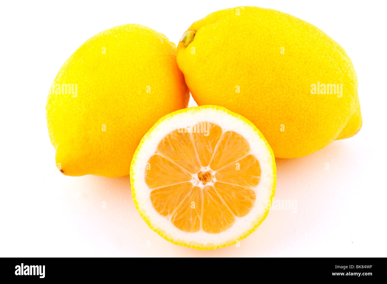 Two Whole Lemons and Half Lemon on Isolated White Background Stock ...